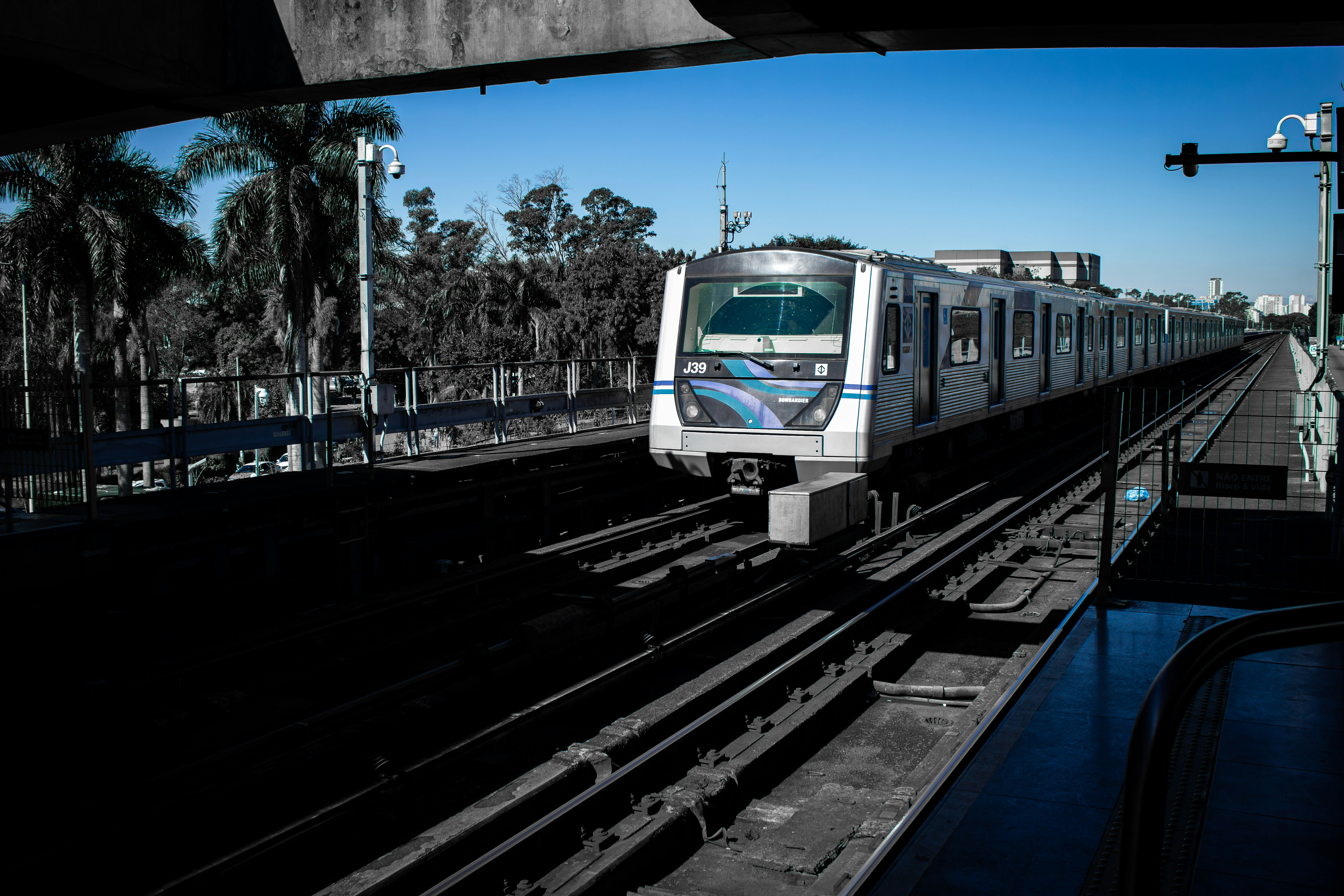 commuter train gliding along elevated tracks at midday