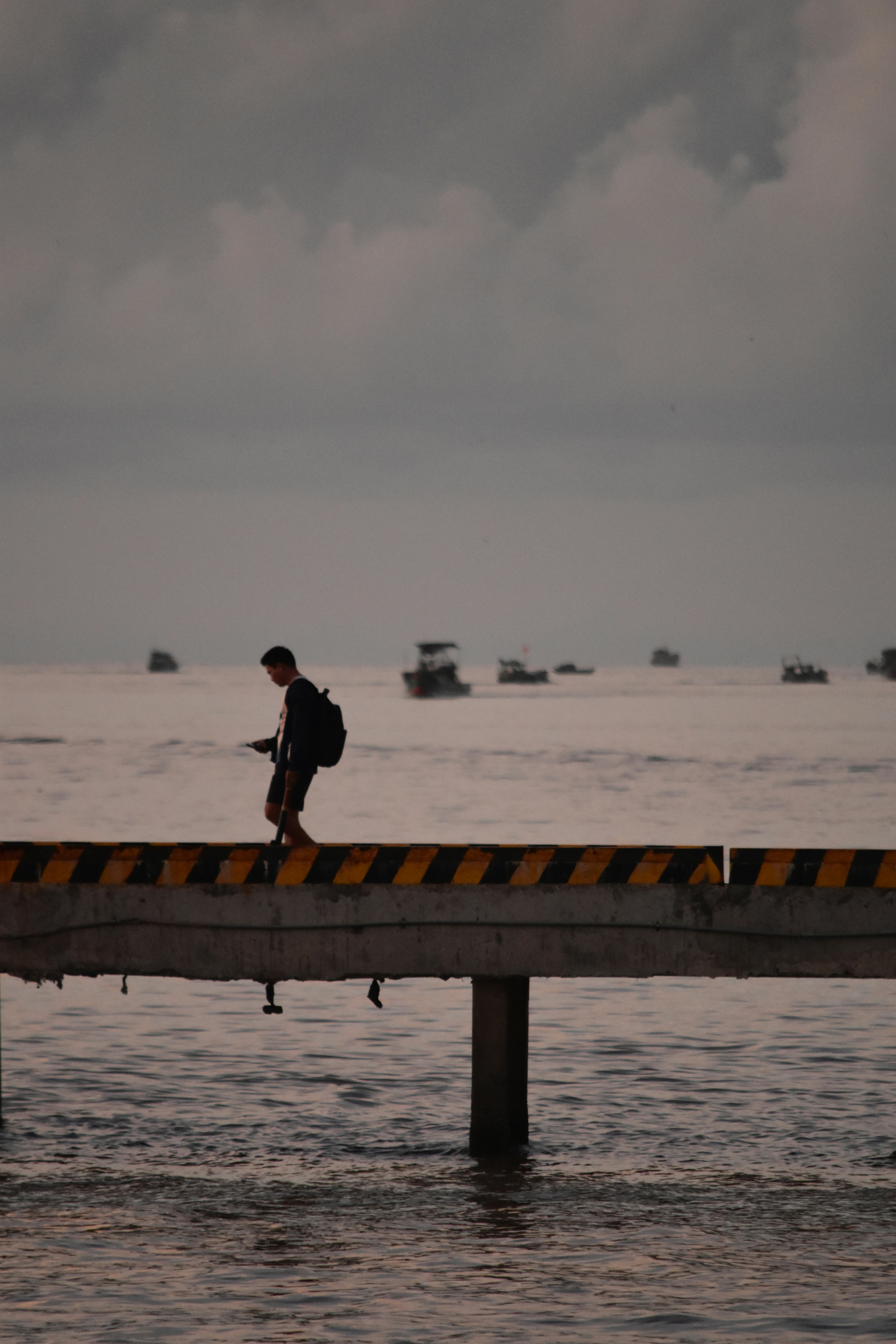 Lone Wanderer on a Quiet Pier at Dusk