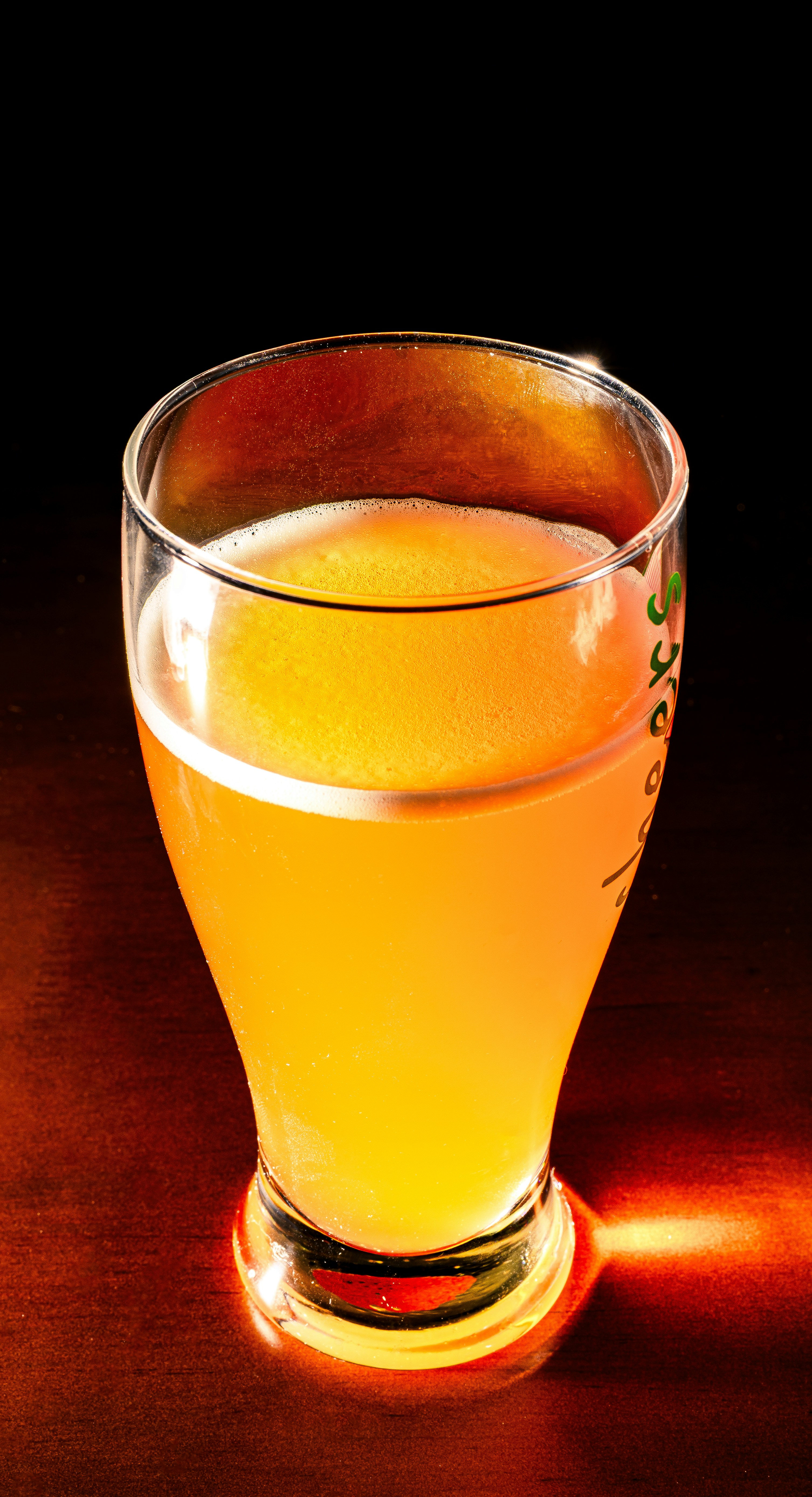 Backlit Citrus: A Glowing Pint in a Dark Studio