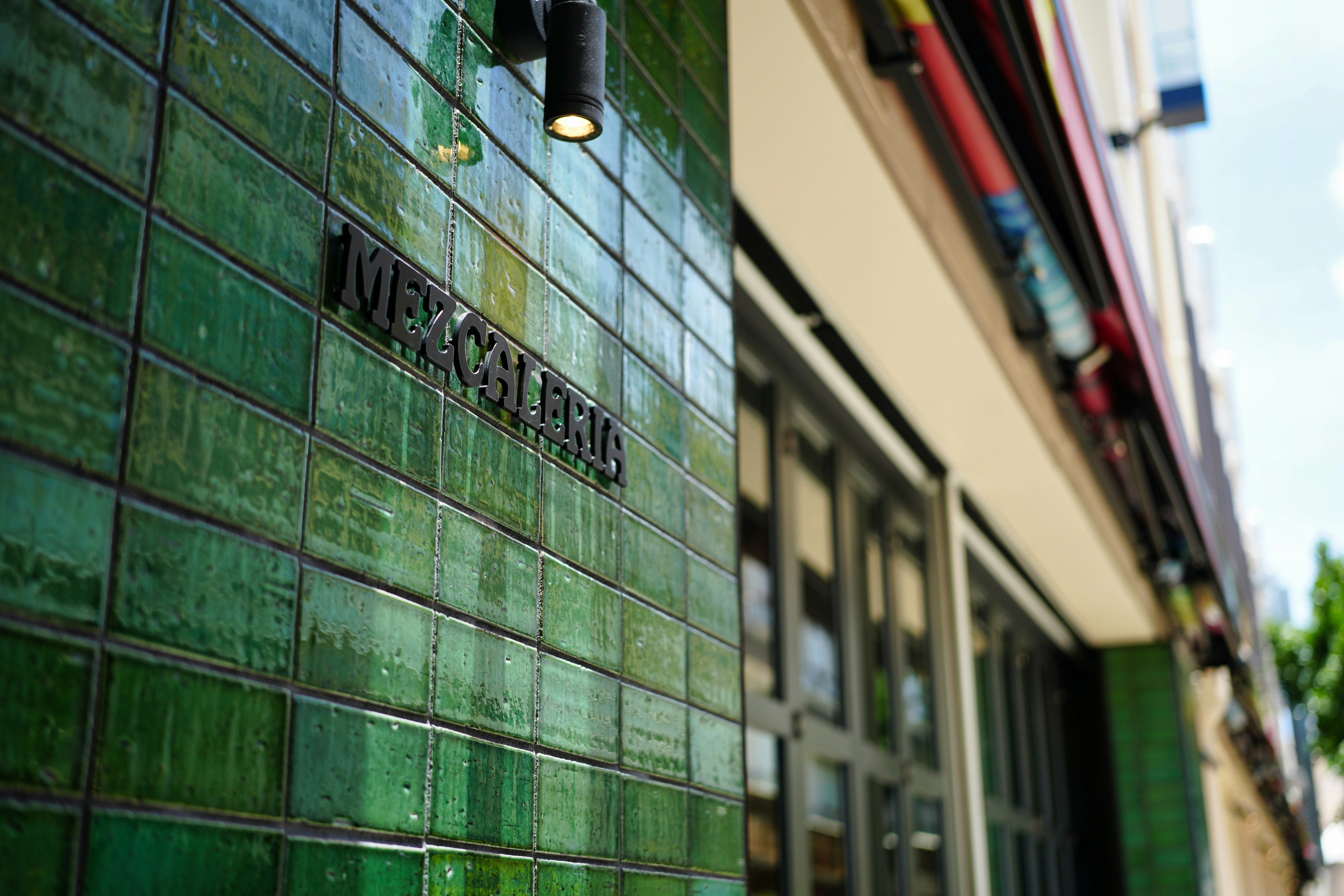 Green Tile Facade: A Quiet Moment with Urban Texture