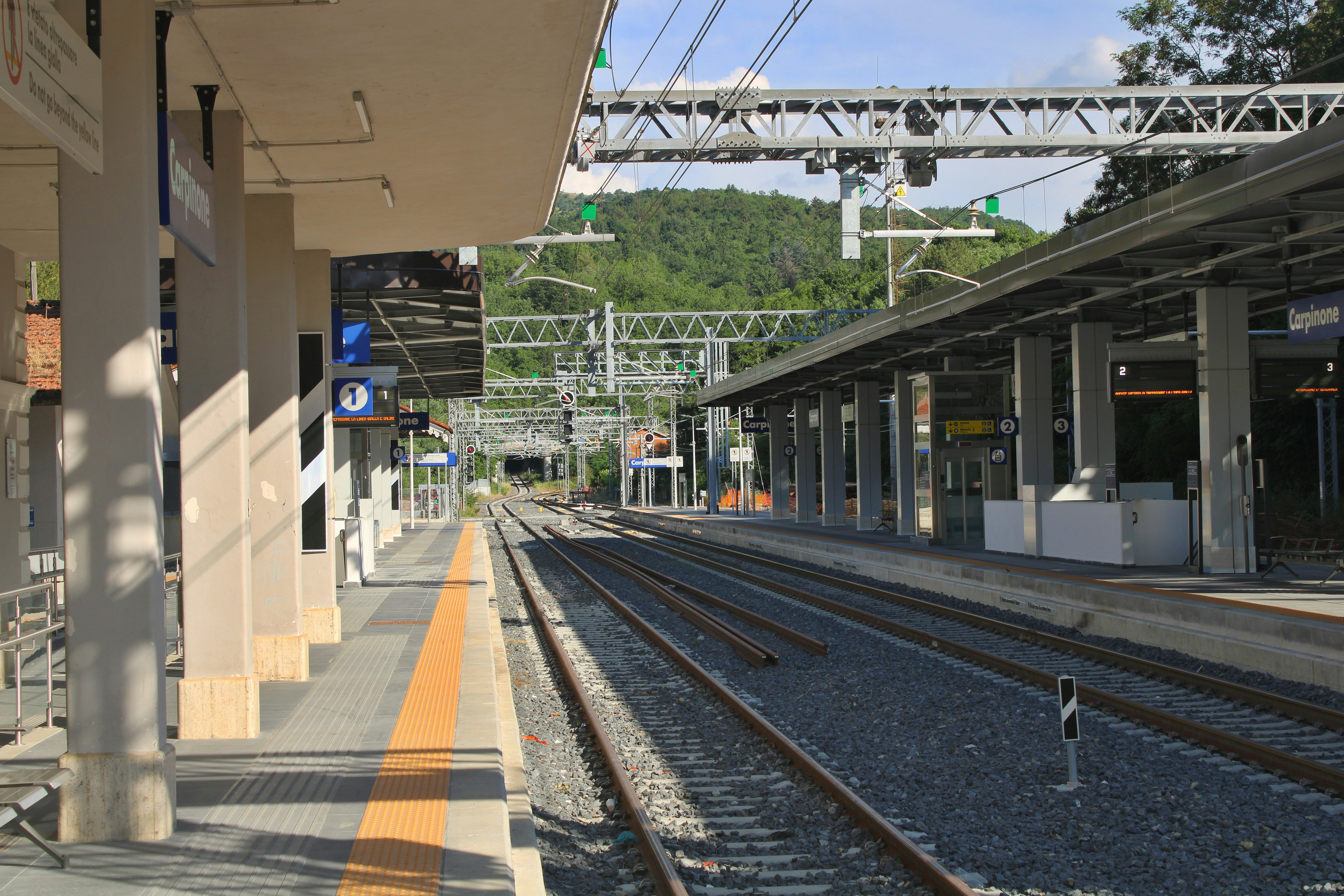Quiet Platform Overpass: Parallel Rails Stretch into the Valley