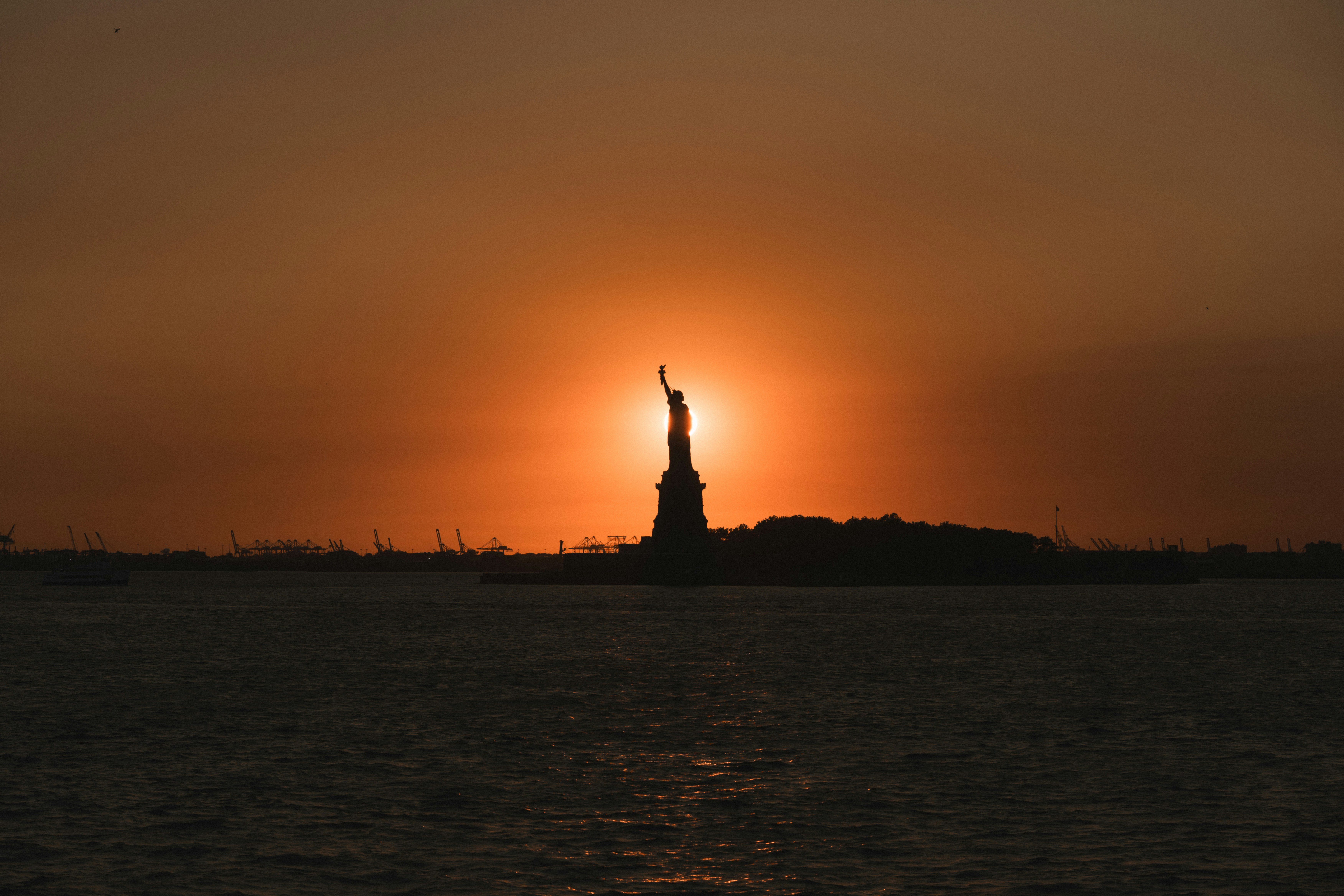 Twilight Sentinel: The Statue of Liberty Silhouette at Sunset