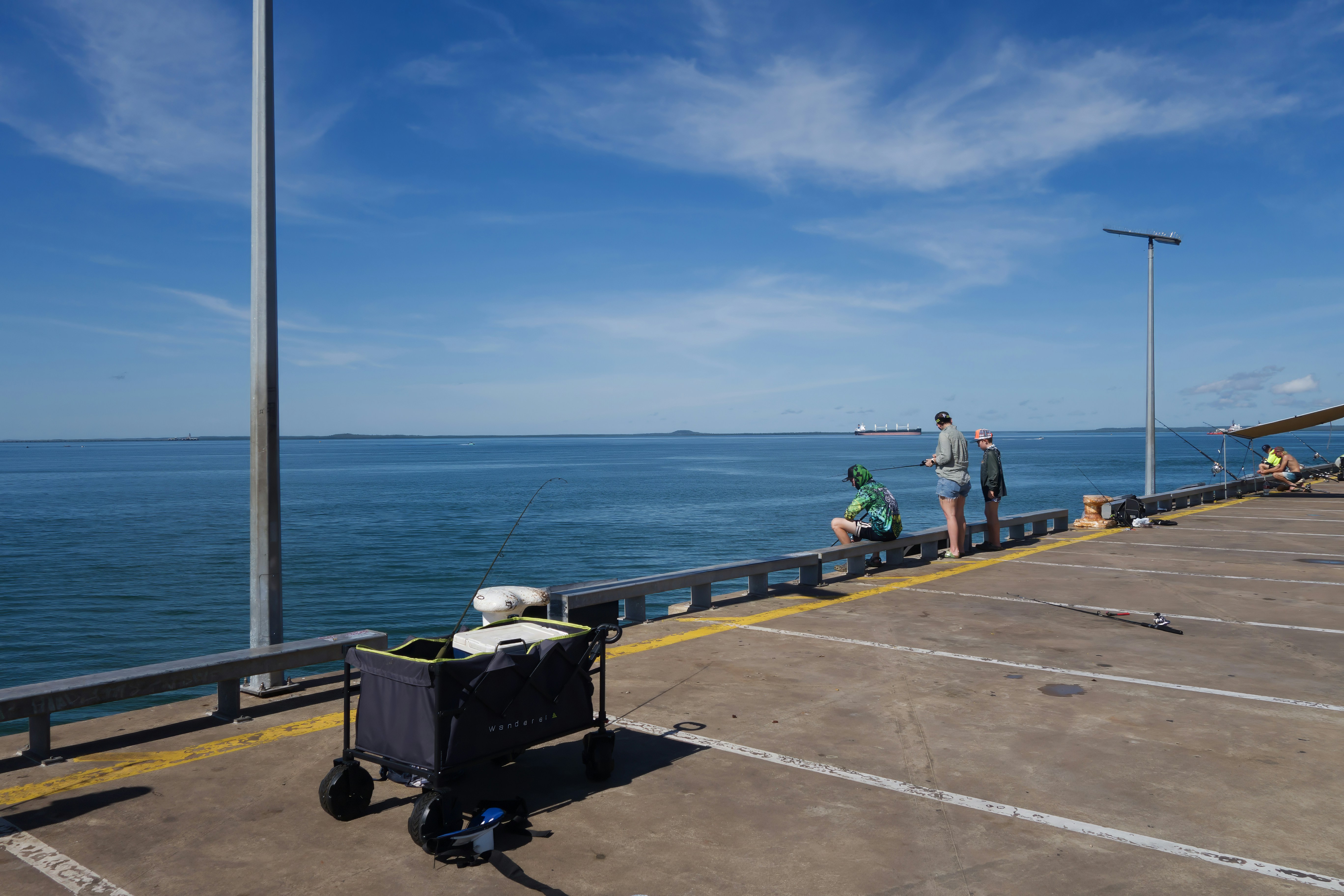 Quiet Angler by the Pier: Morning Cast Along an Open Sea