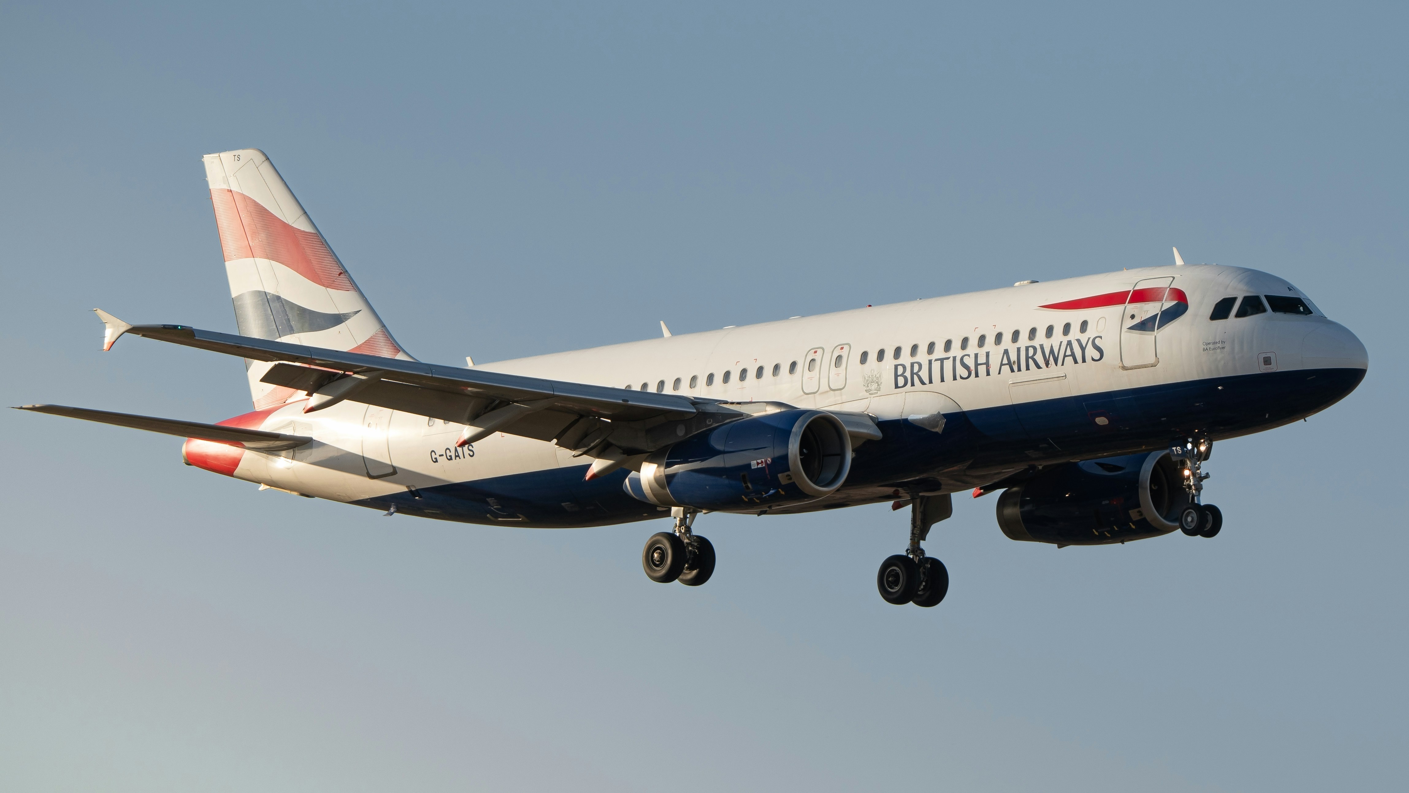 British Airways A320/A321 in ascent: chrome fuselage against blue sky