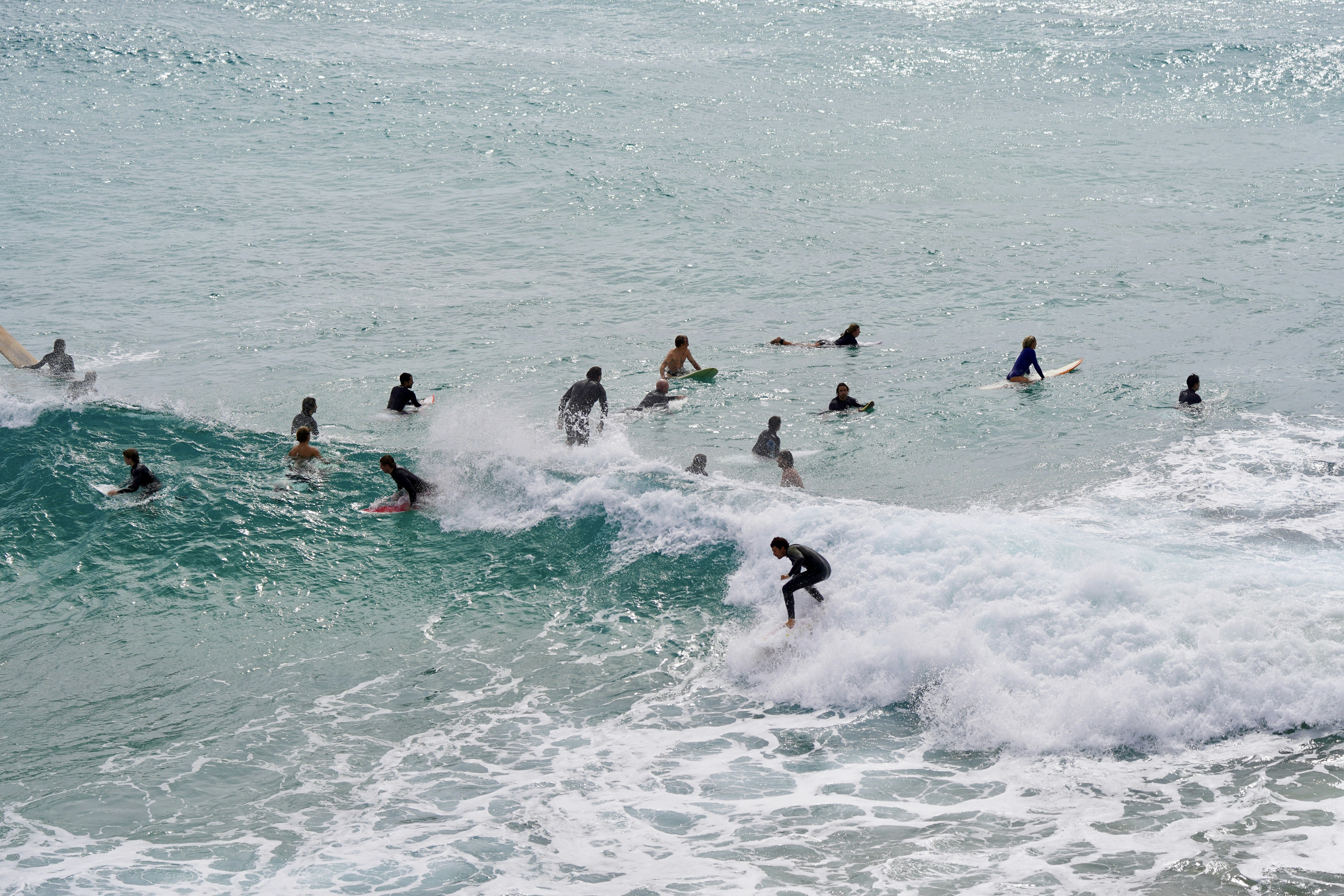 Surfing Silhouettes Riding Caramel-Tinted Breakers