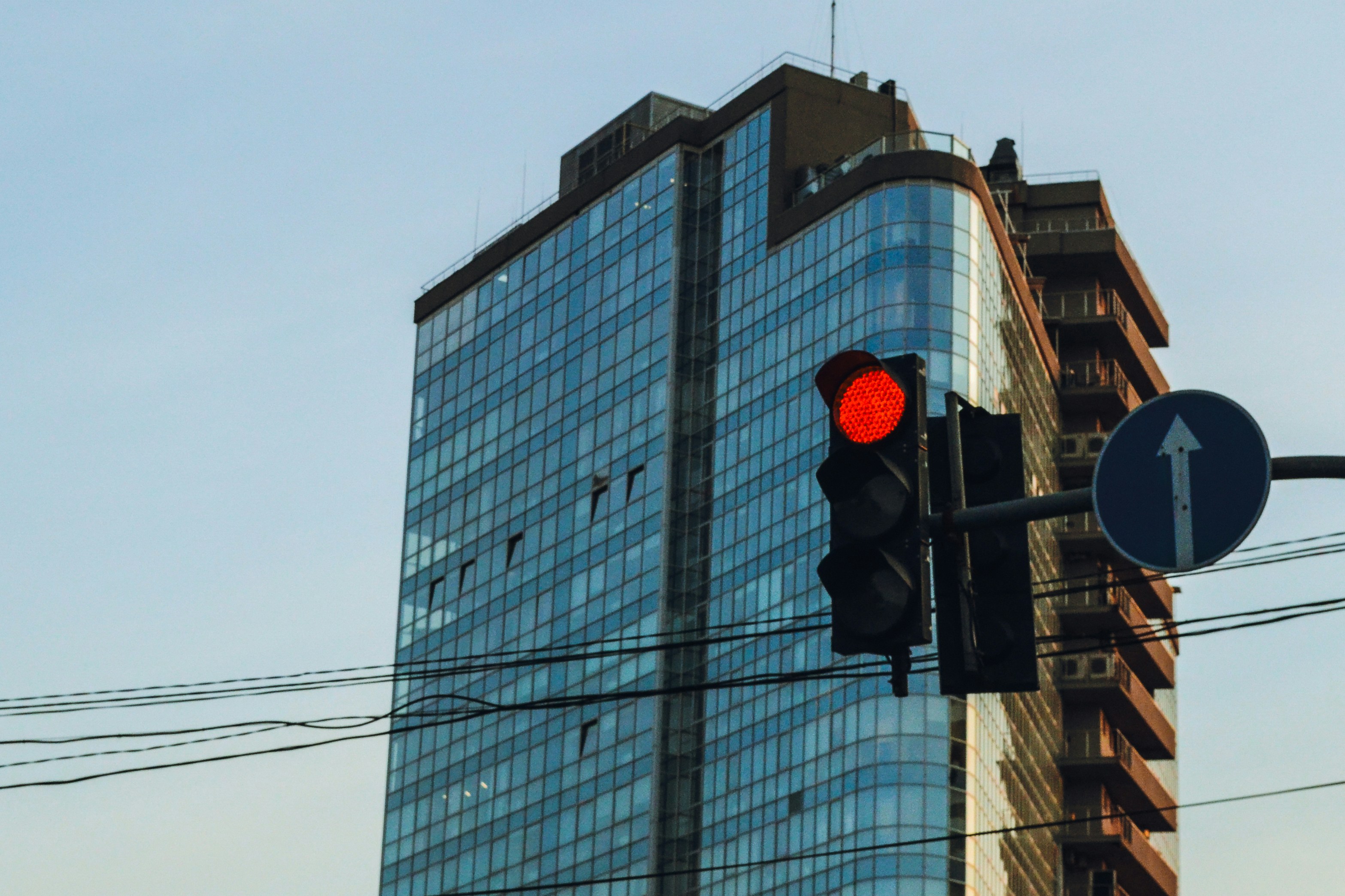 Rising Glass Tower Framed by a Red Signal
