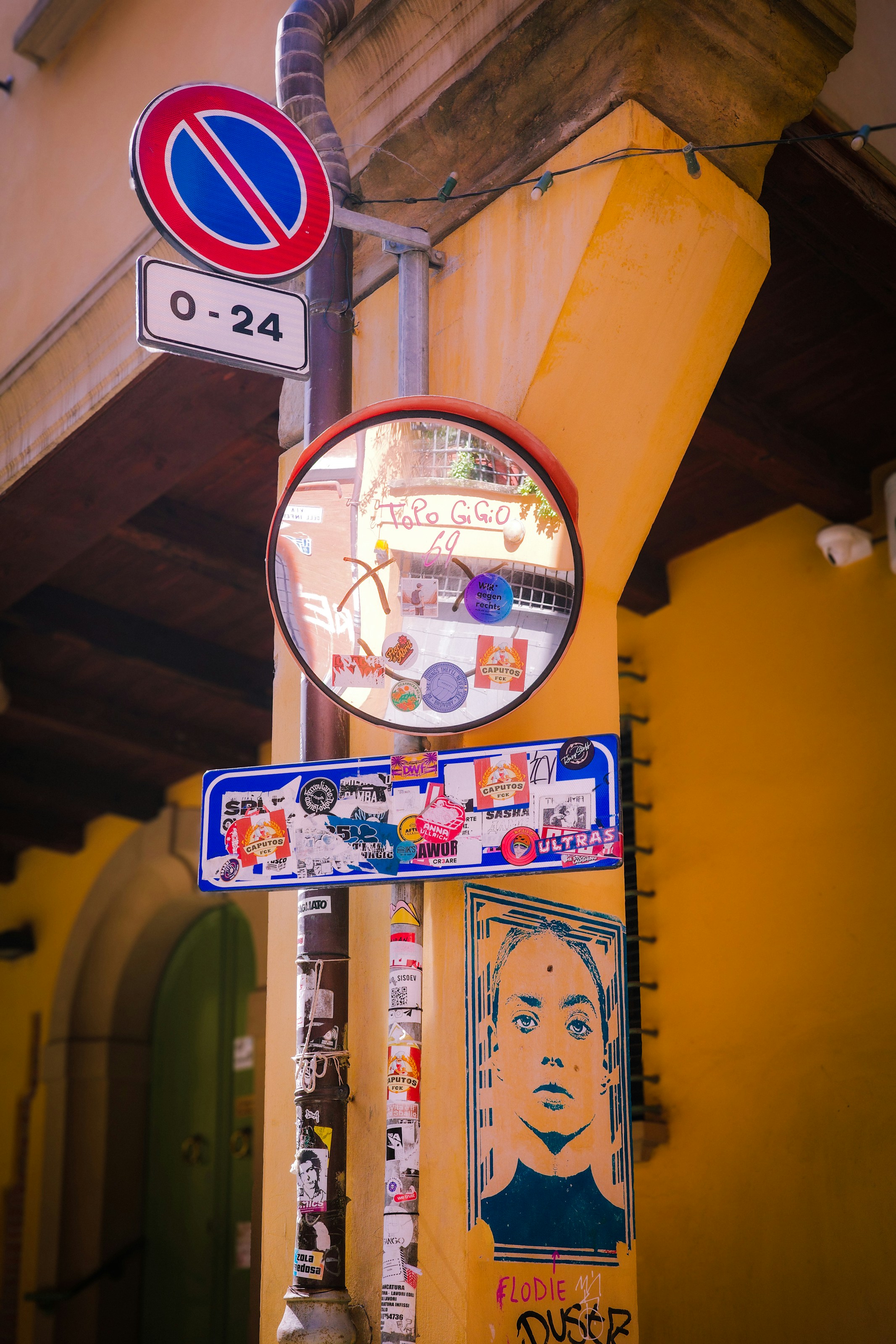 Rounded Reflector, Street Sticker Blitz under a Yellow Arch