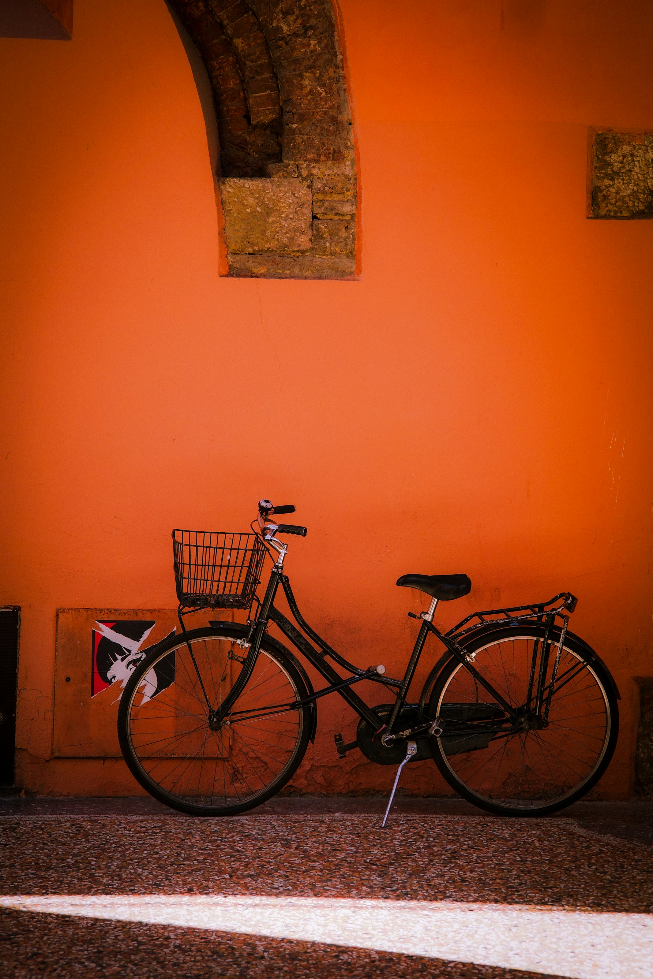 Orange Wall, Black Bicycle: A Quiet Urban Moment