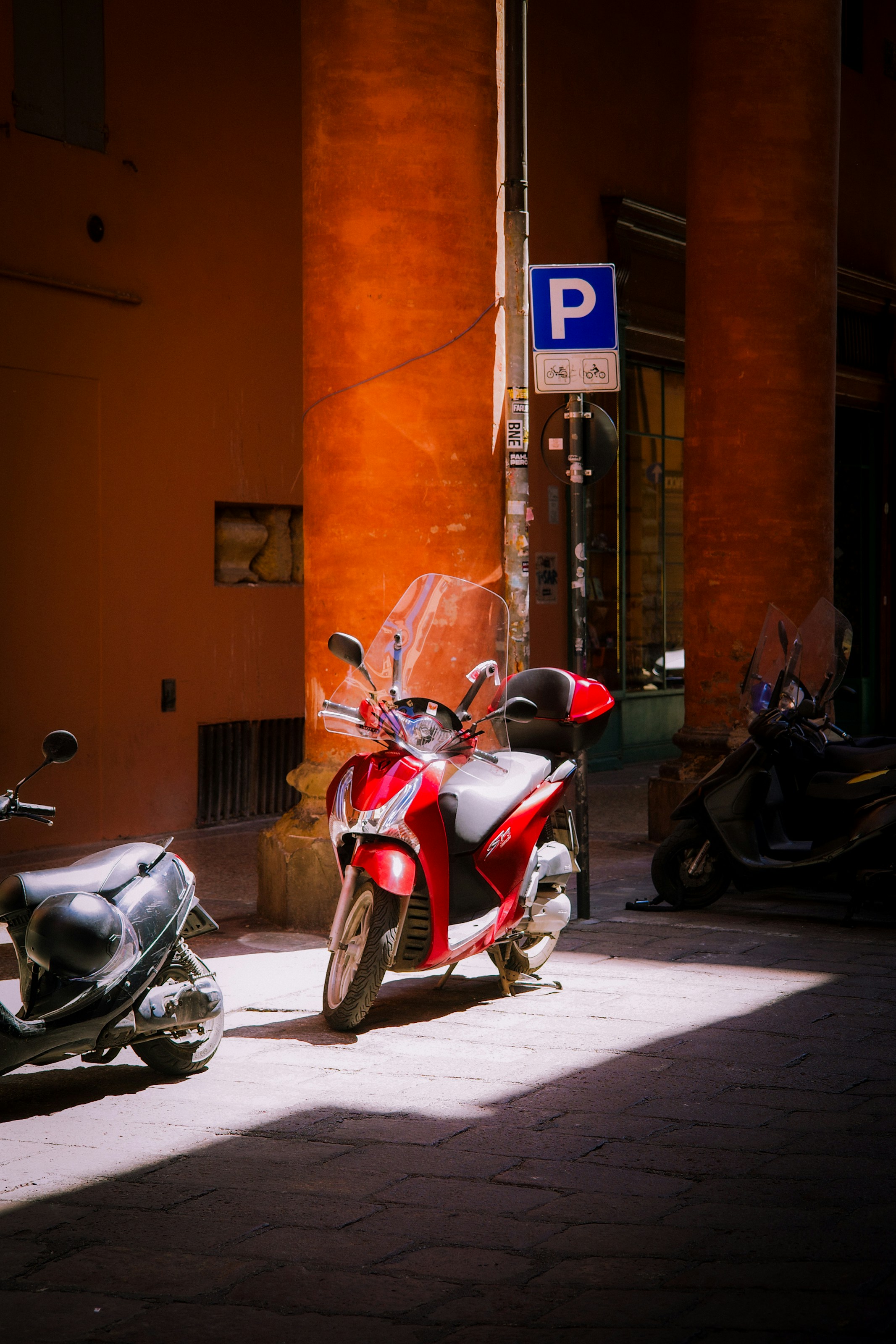 Red Scooter at Dappled City Shade