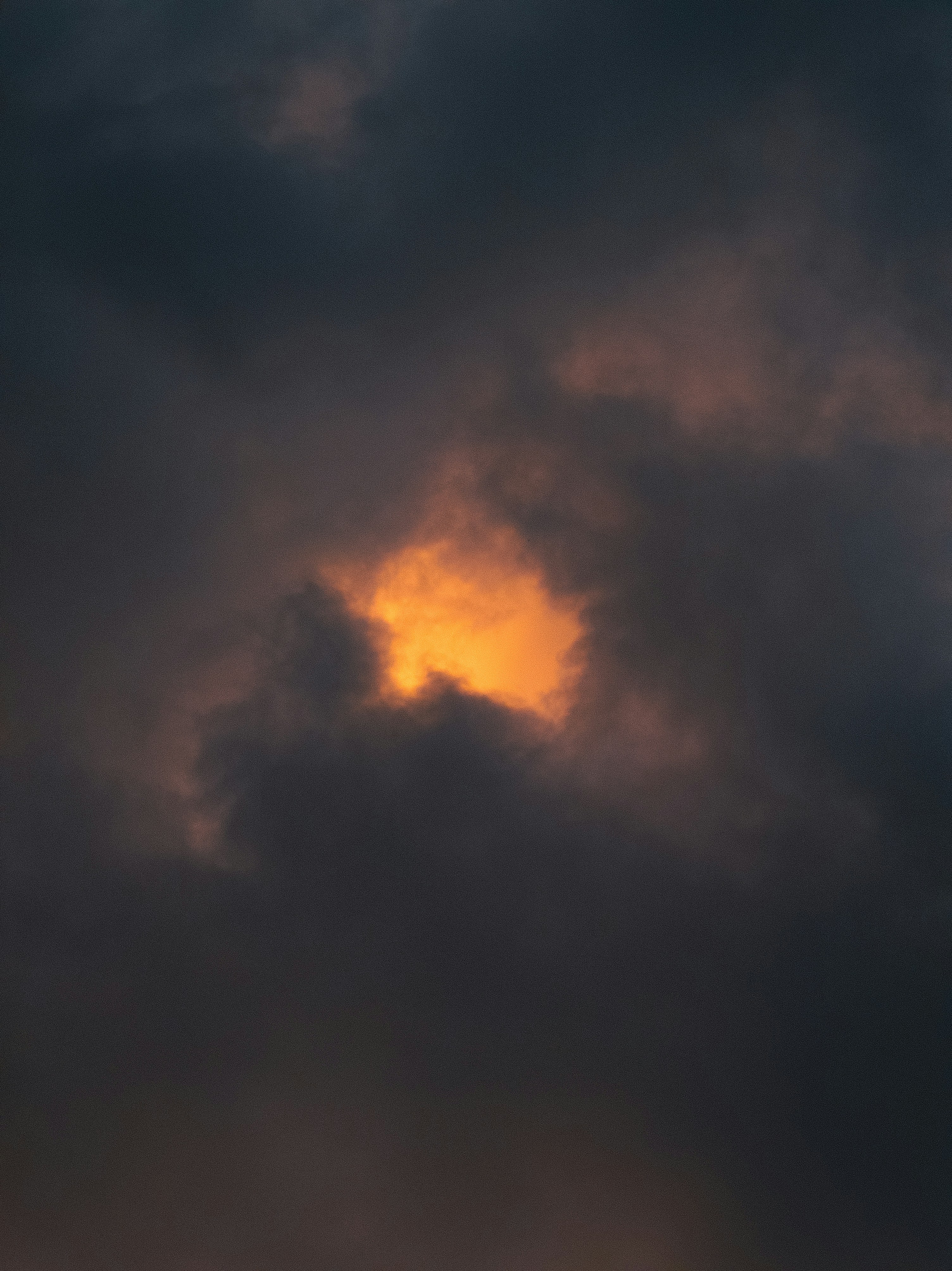 Gaping Ember: An Evanescent Flame in Dark Clouds