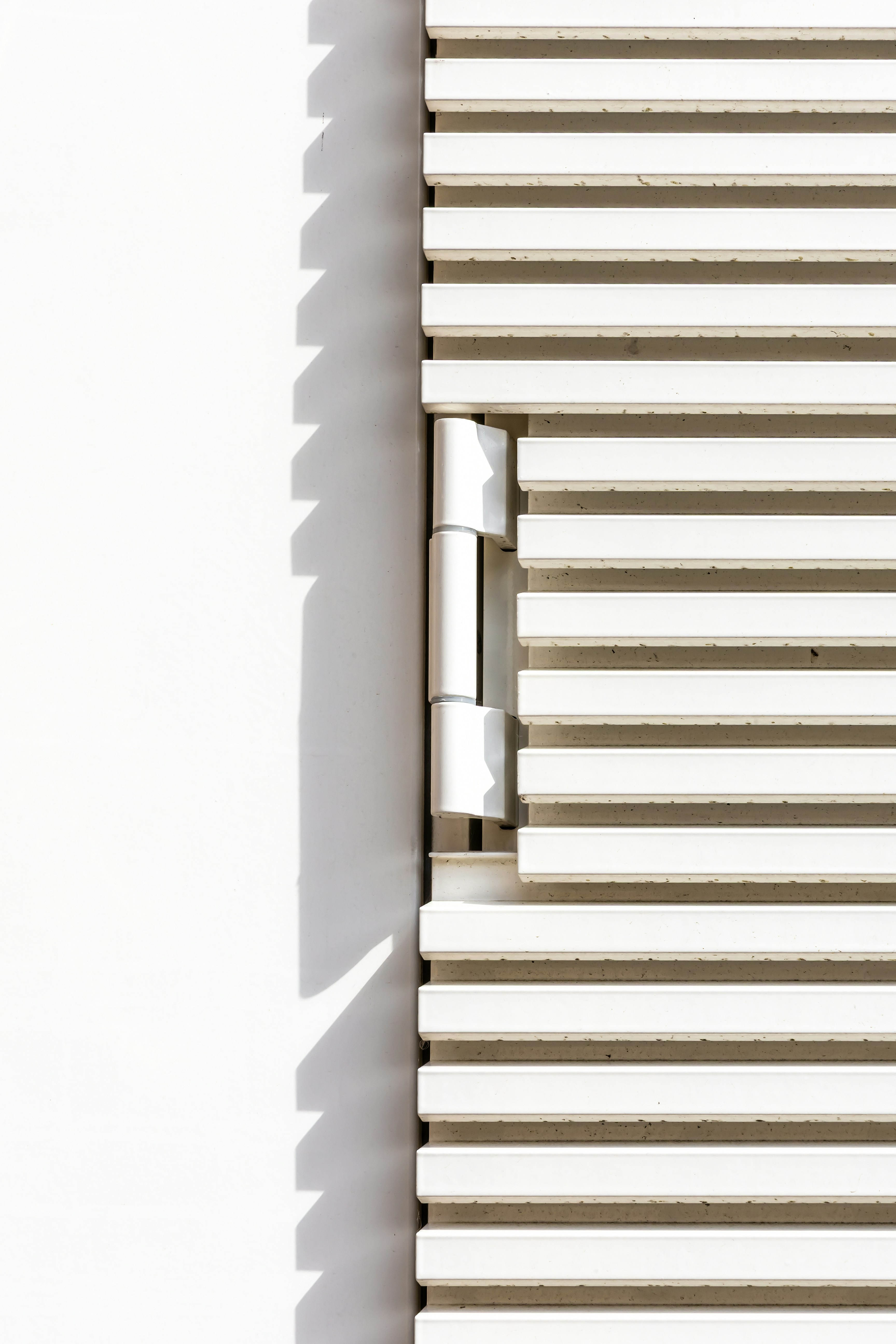Minimalist Shutter: A Close-Up of Wall Slats and Shadow