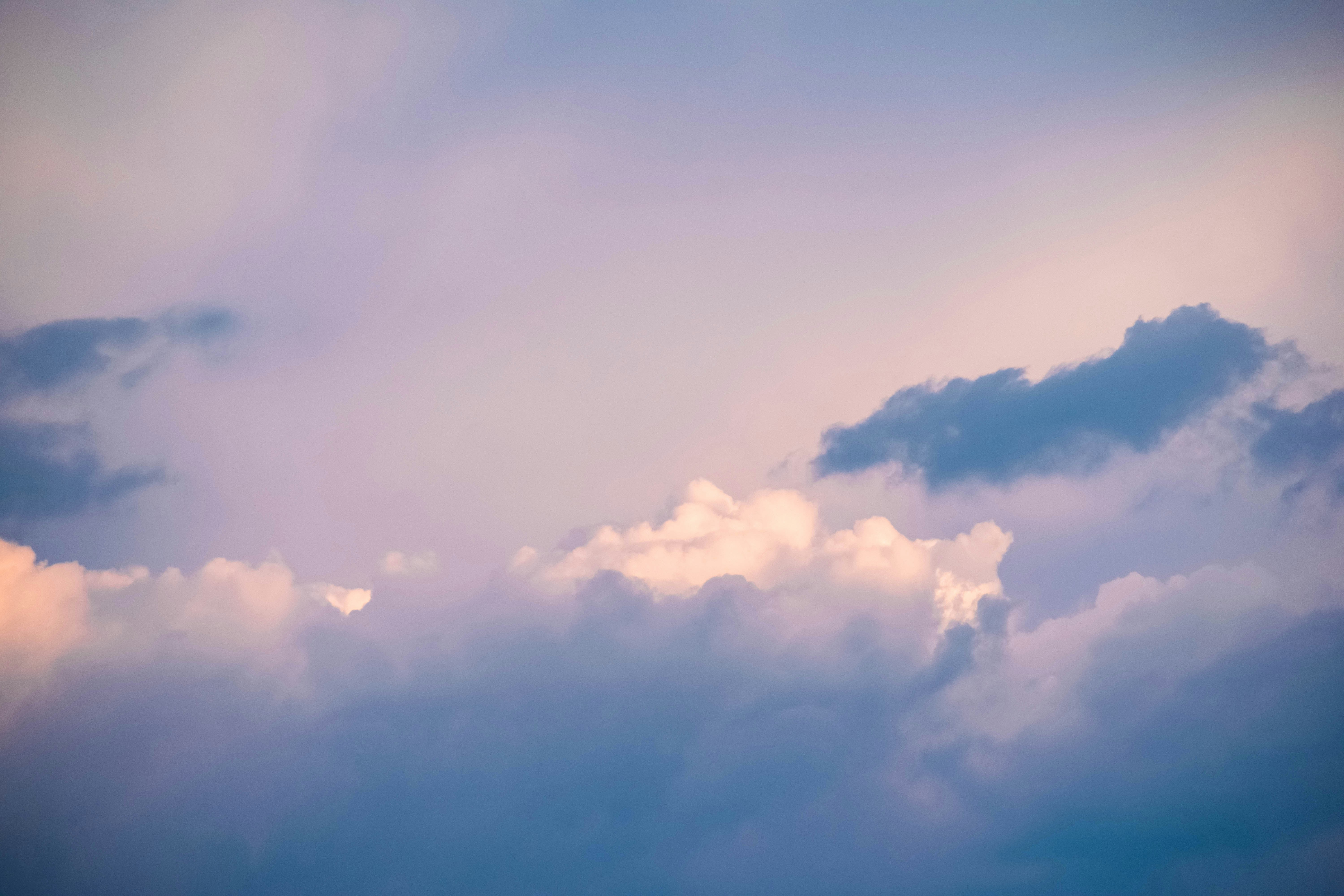 Dawn’s Gentle Lift: Soft Pink Clouds Over a Quiet Blue Ridge