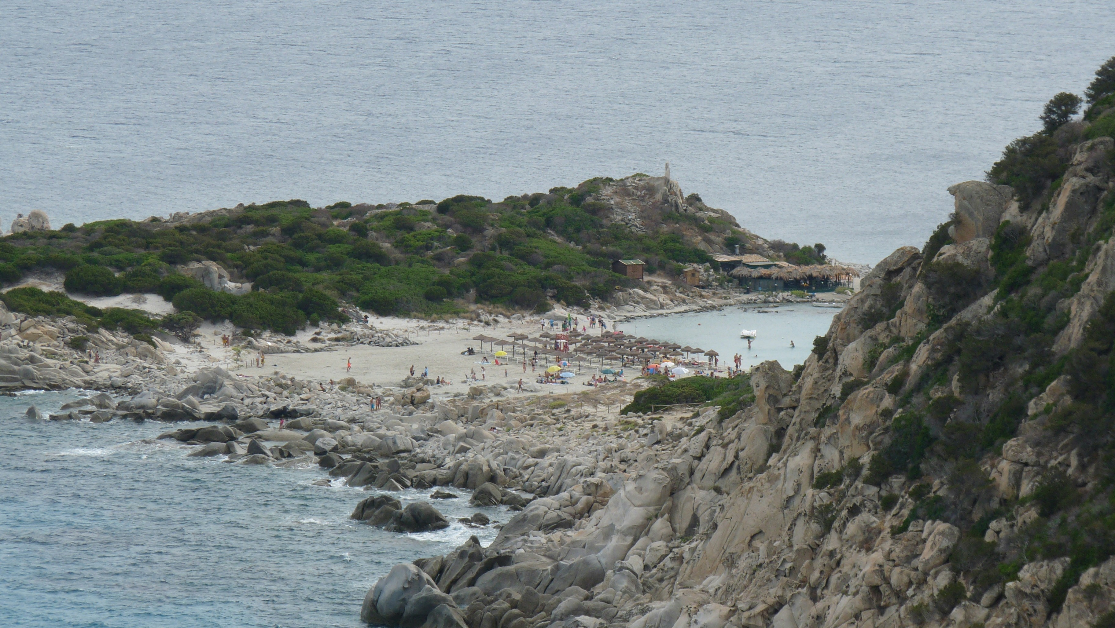 Cliffside Cove: A Pebbled Beach Nestled Between Stone and Sea