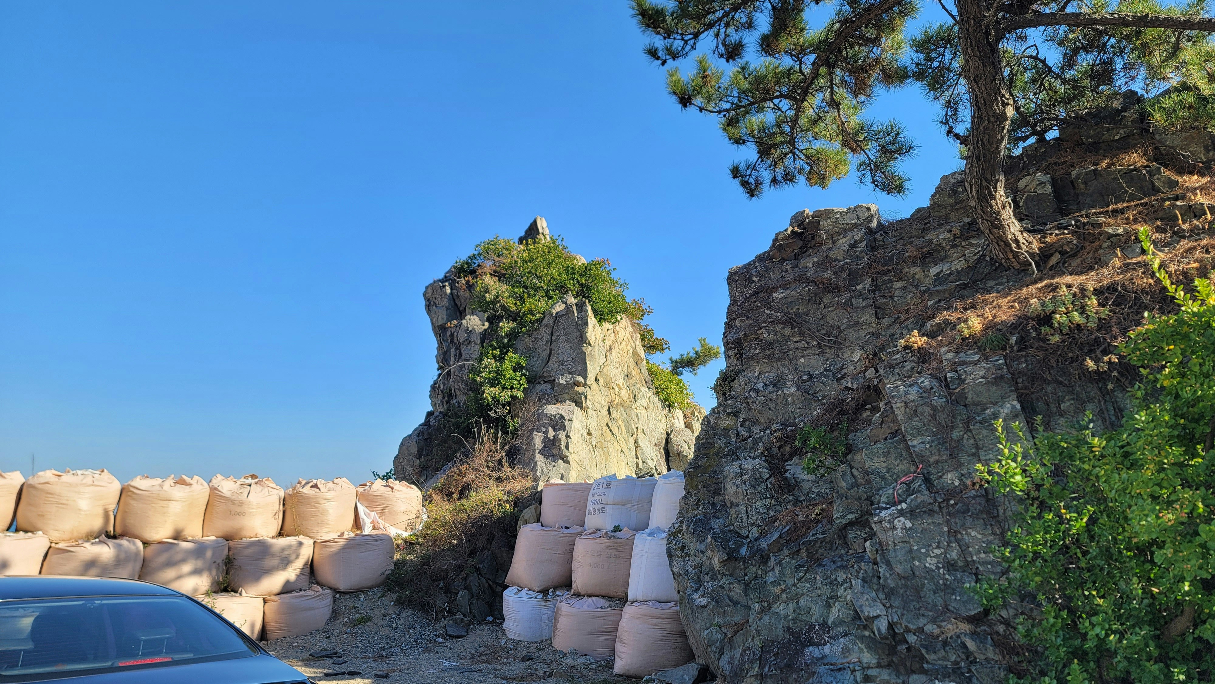 Rock Wall and Sandbag Barrier under a Clear Blue Sky