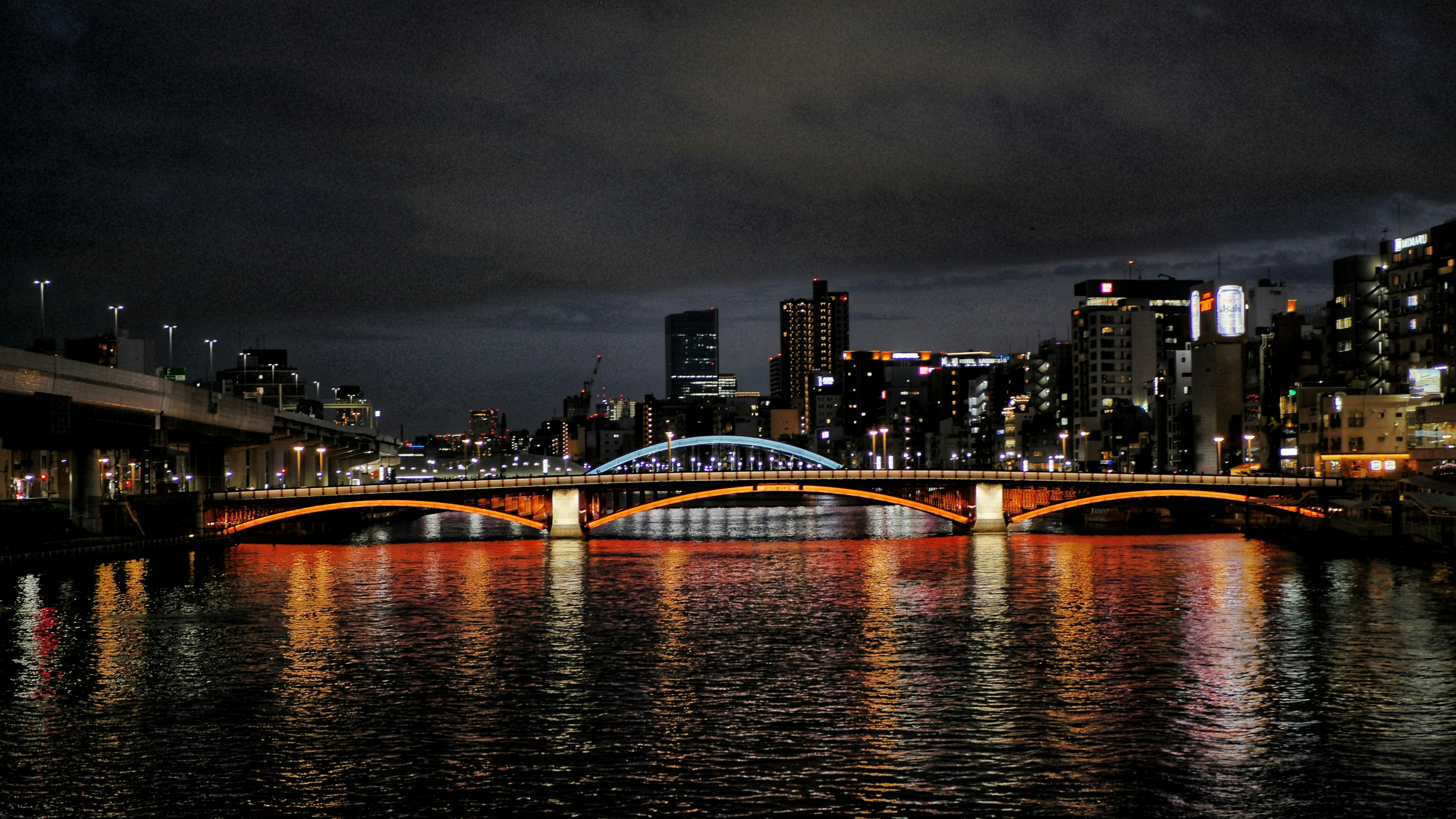 Illuminated River Run: Neon Bridges Reflect Across Midnight Waters