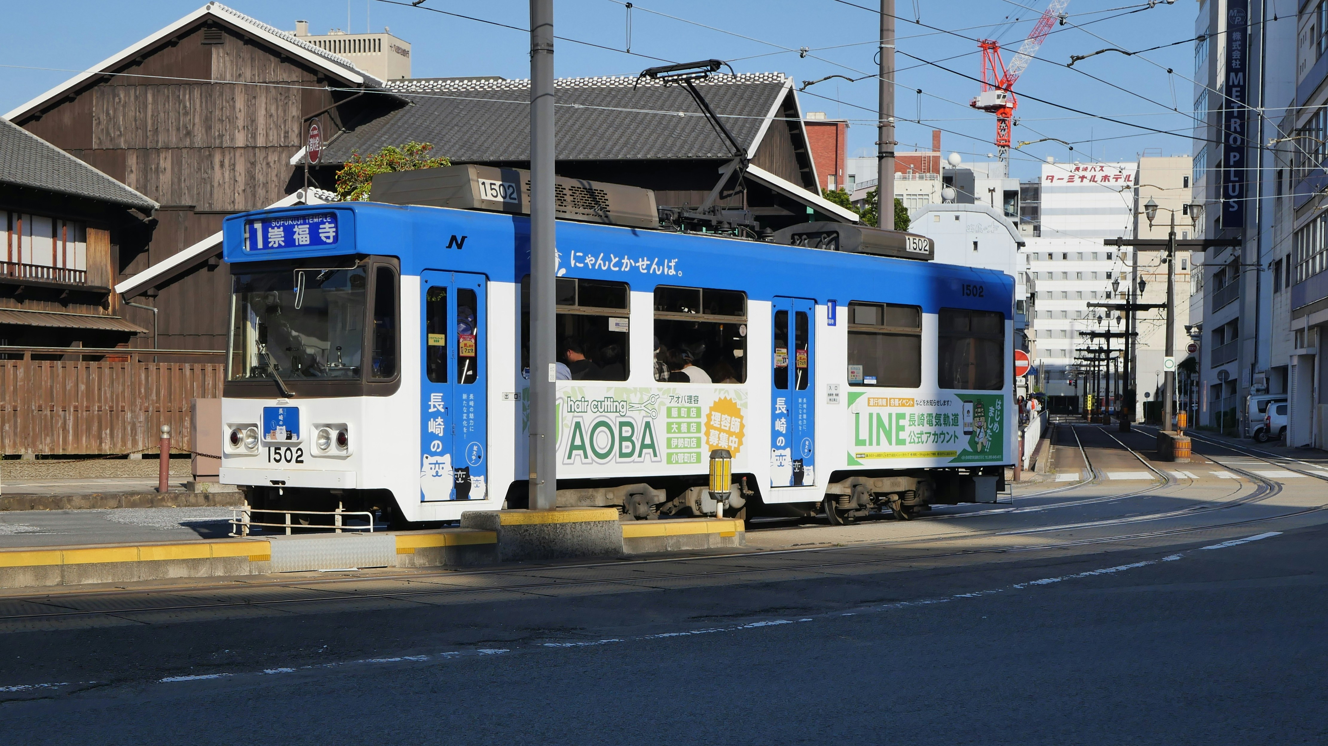 Blue Tram on a Quiet Japanese Street