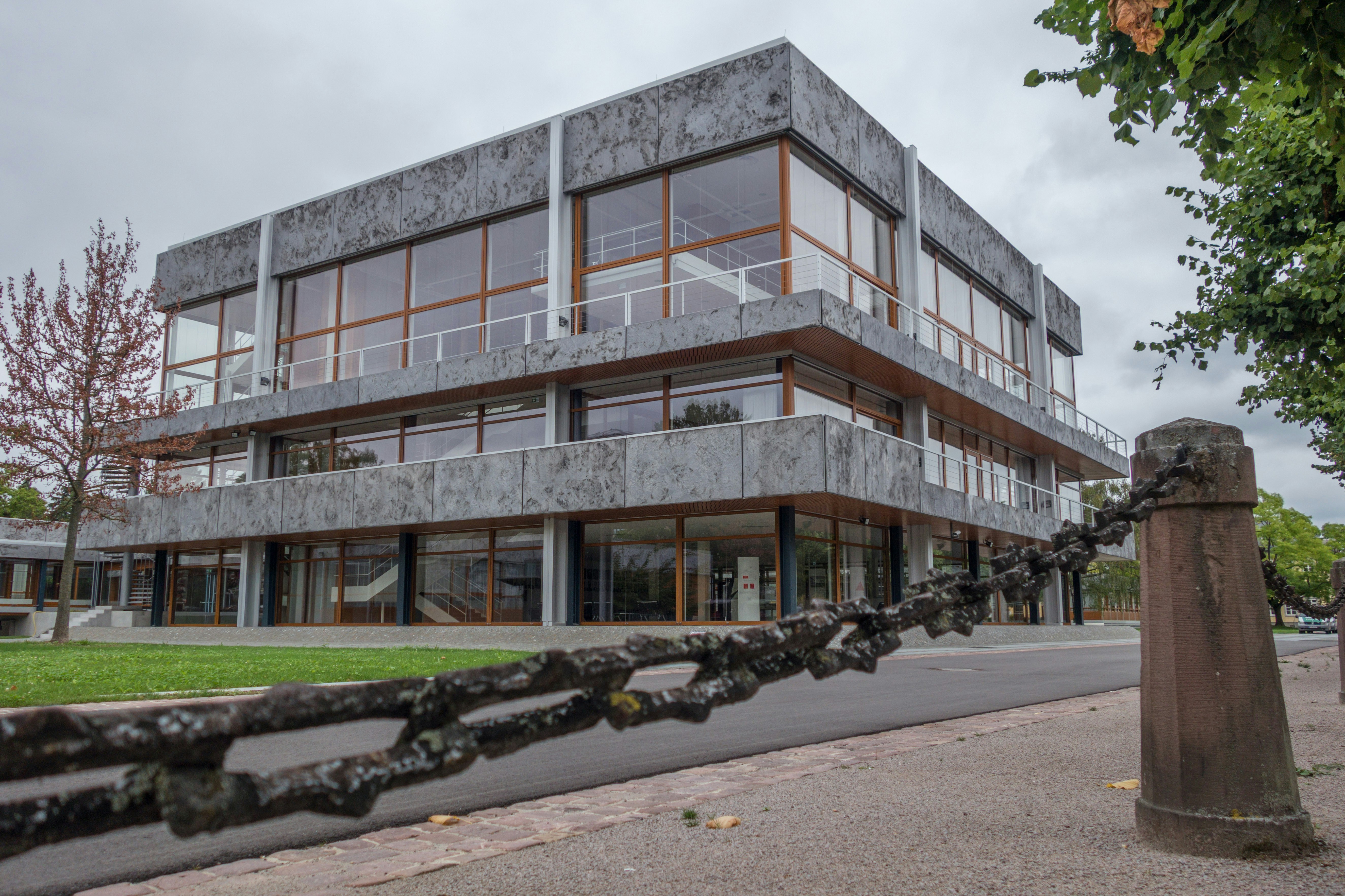 Concrete Brutalist Headquarters Rising Over a Quiet Street