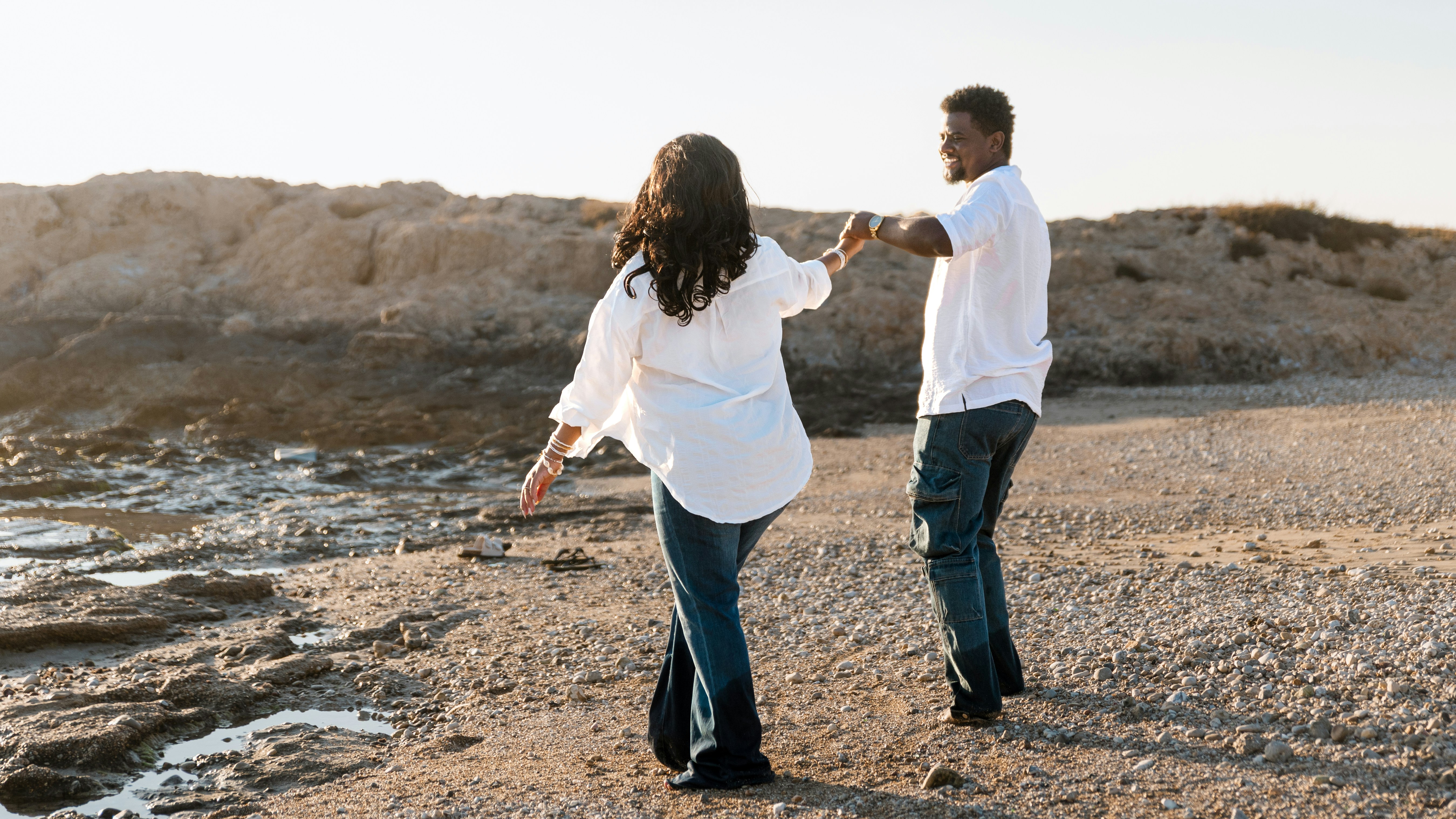 A Quiet Beach Moment: Guiding Hands at Dune’s Edge
