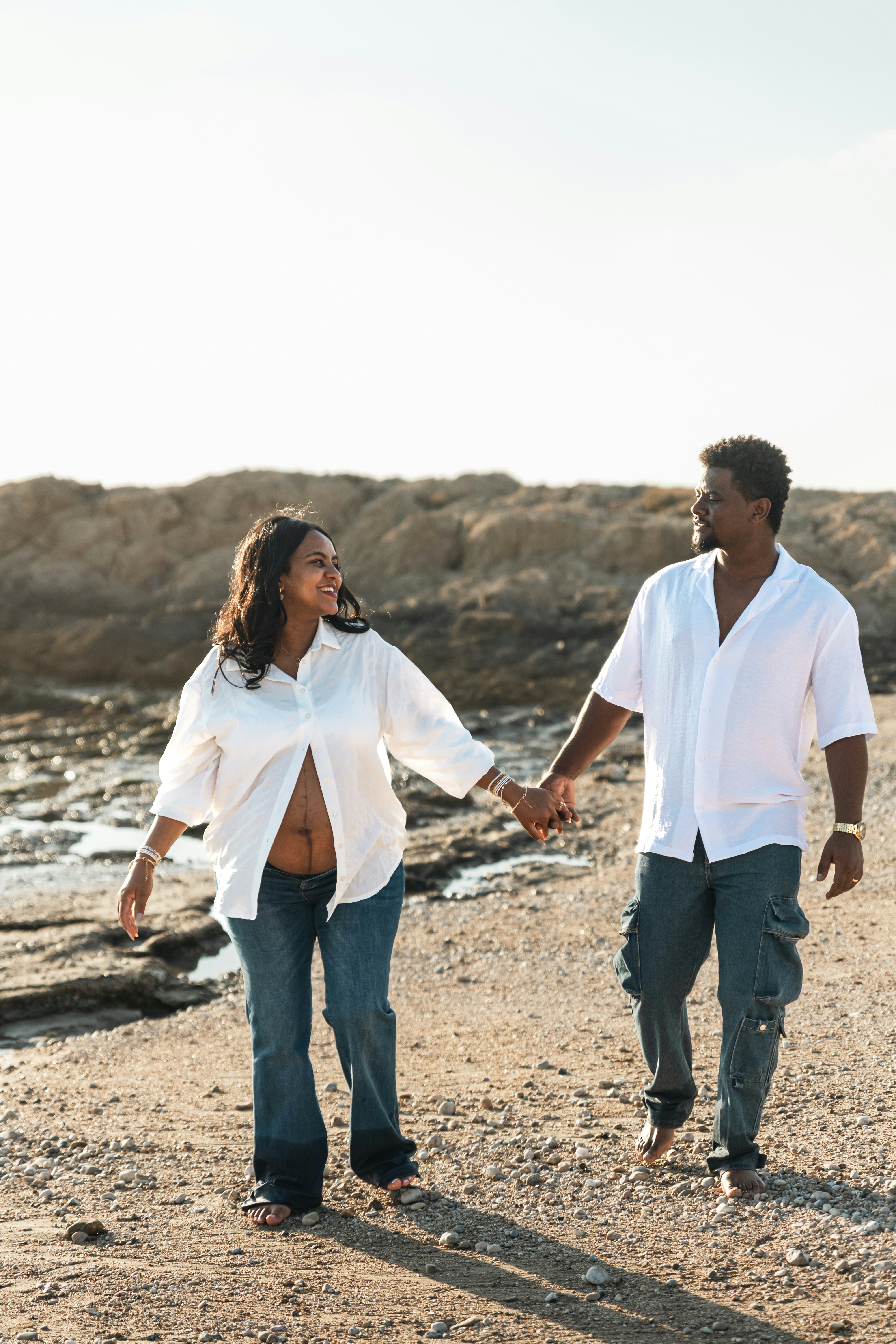Holding Hands at the Tide: A Sunset Walk on the Shore
