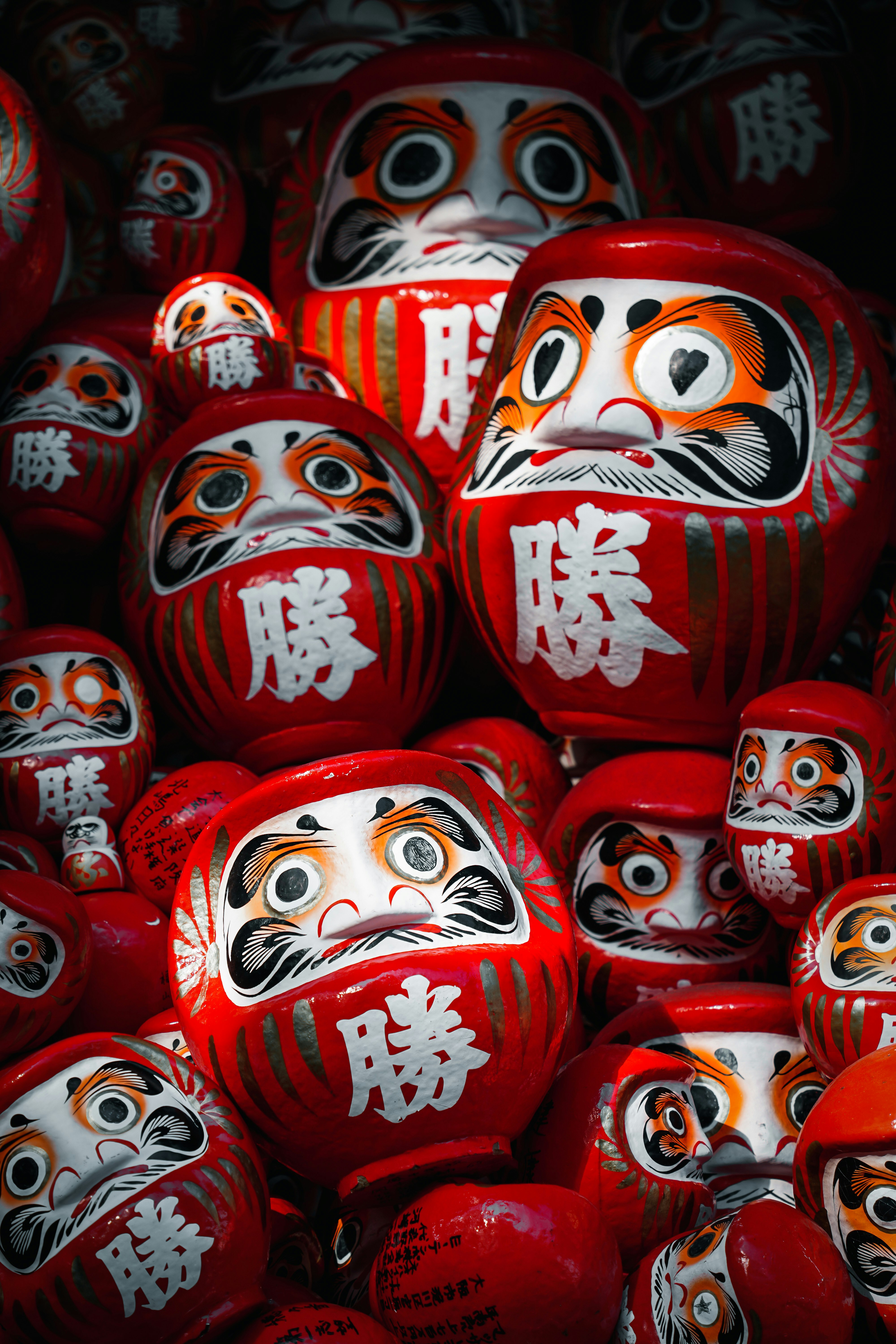 Red Daruma Stack: Portraits of Focus Amid a Sea of Symbolic Orbs