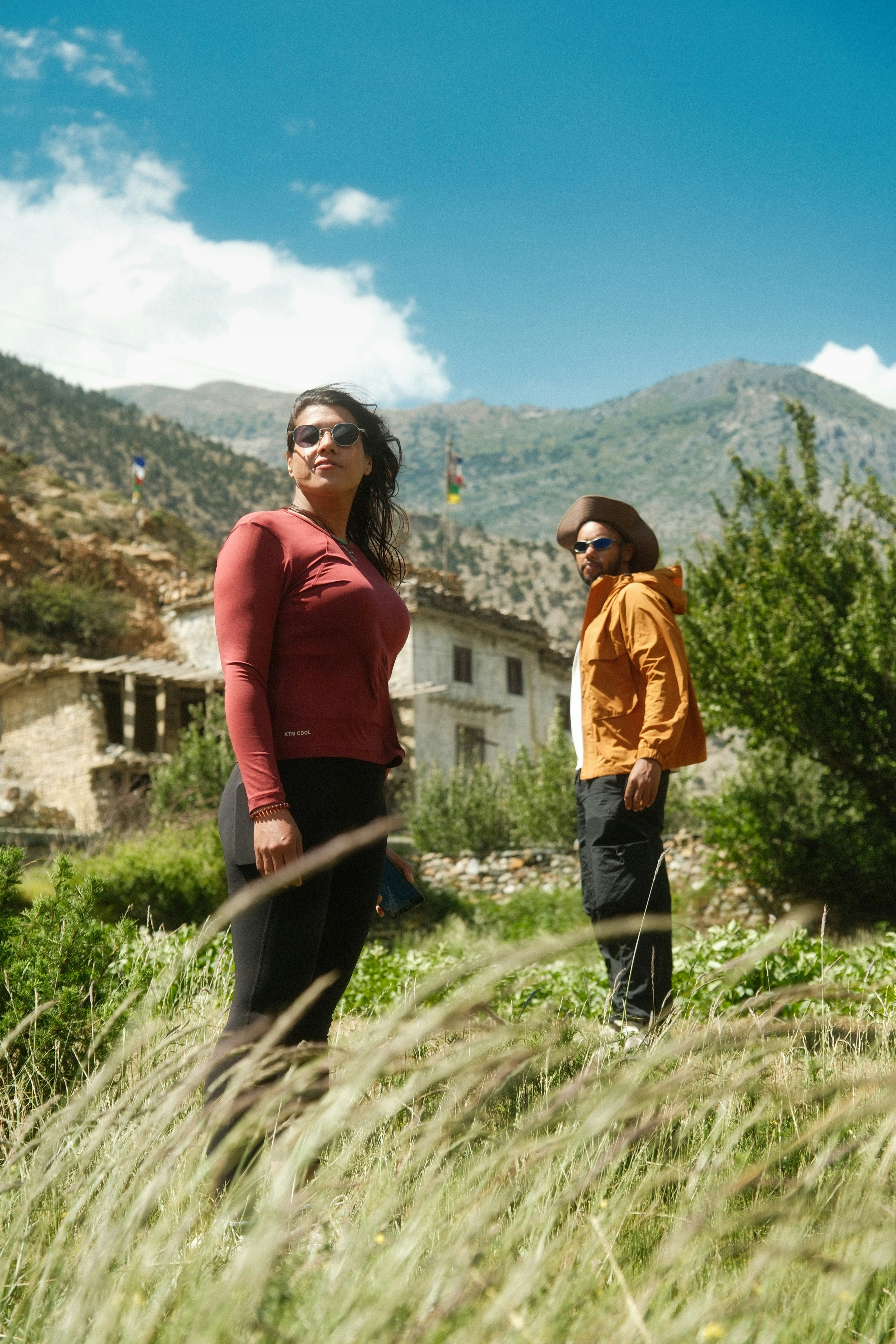 Two Travelers in a Mountain Village Under a Clear Sky