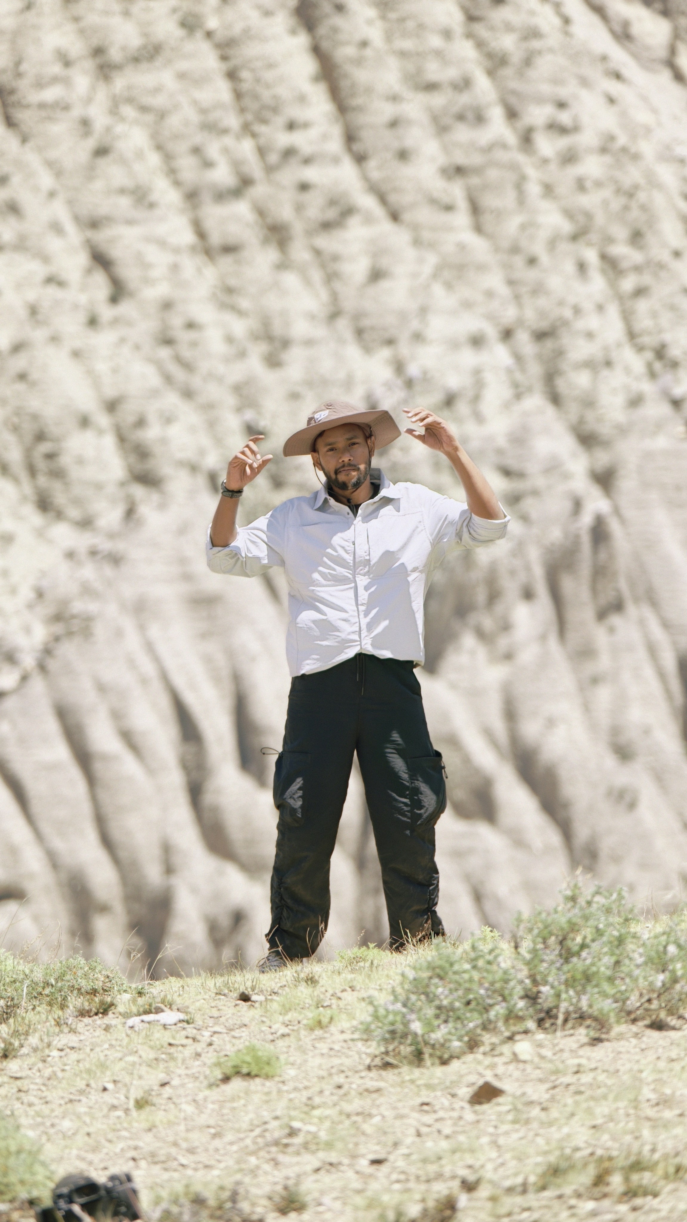 Sunlit Explorer: Portrait of a Man Against Weathered Canyon