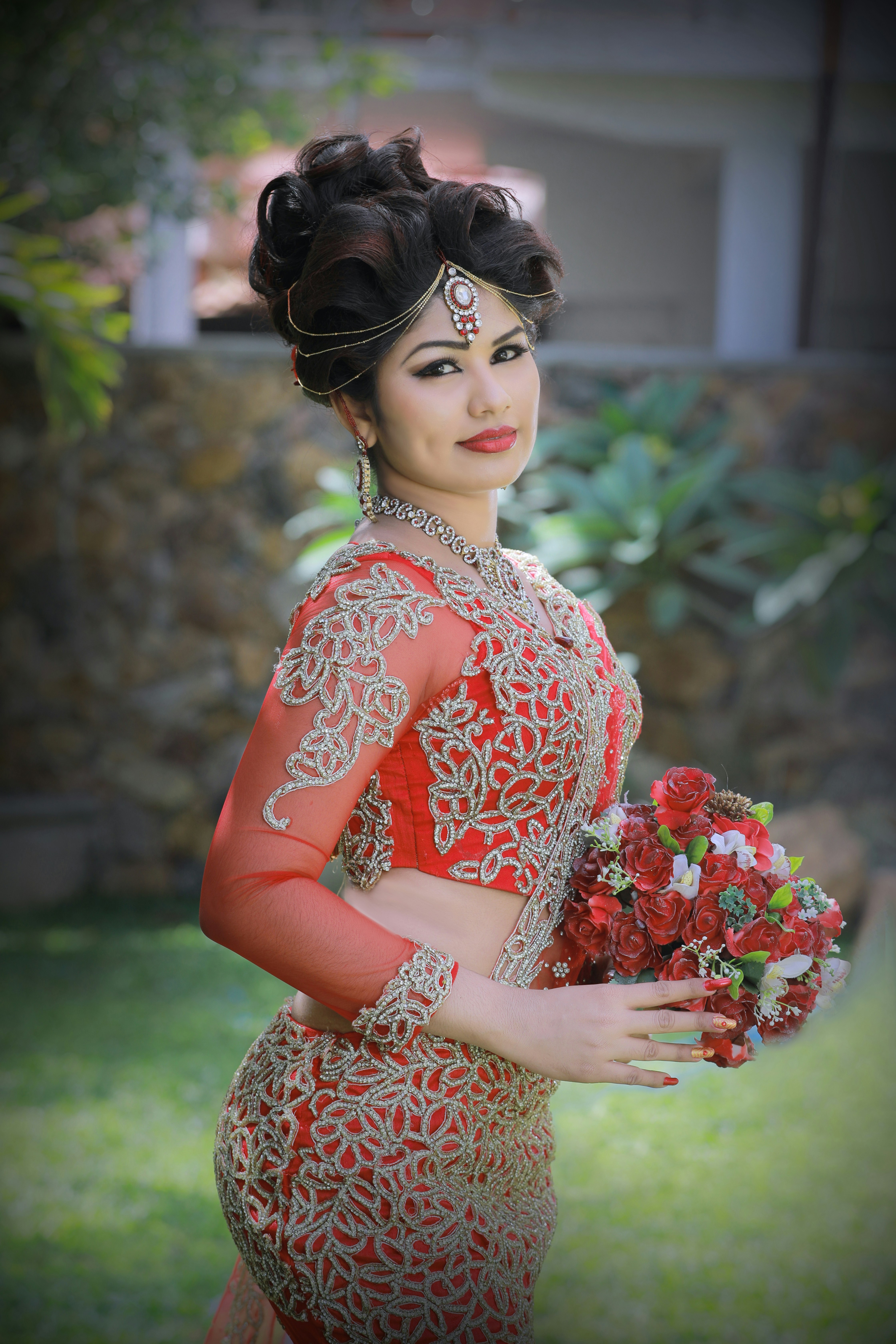 Elegance in Embroidered Red: Bridal Couture with Bouquets of Red Roses