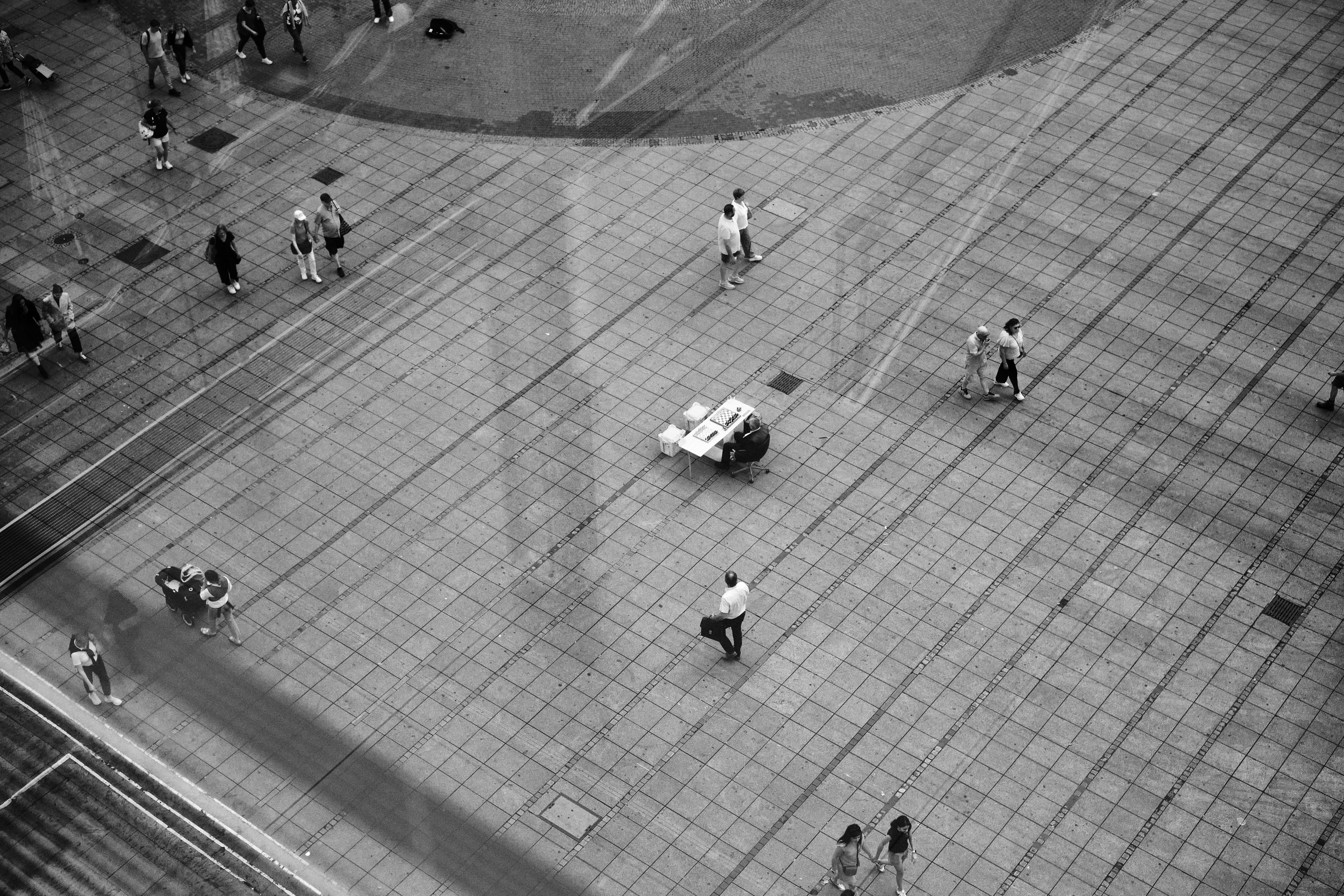 Muted Square: Scatter of Pedestrians and a Central Scooter
