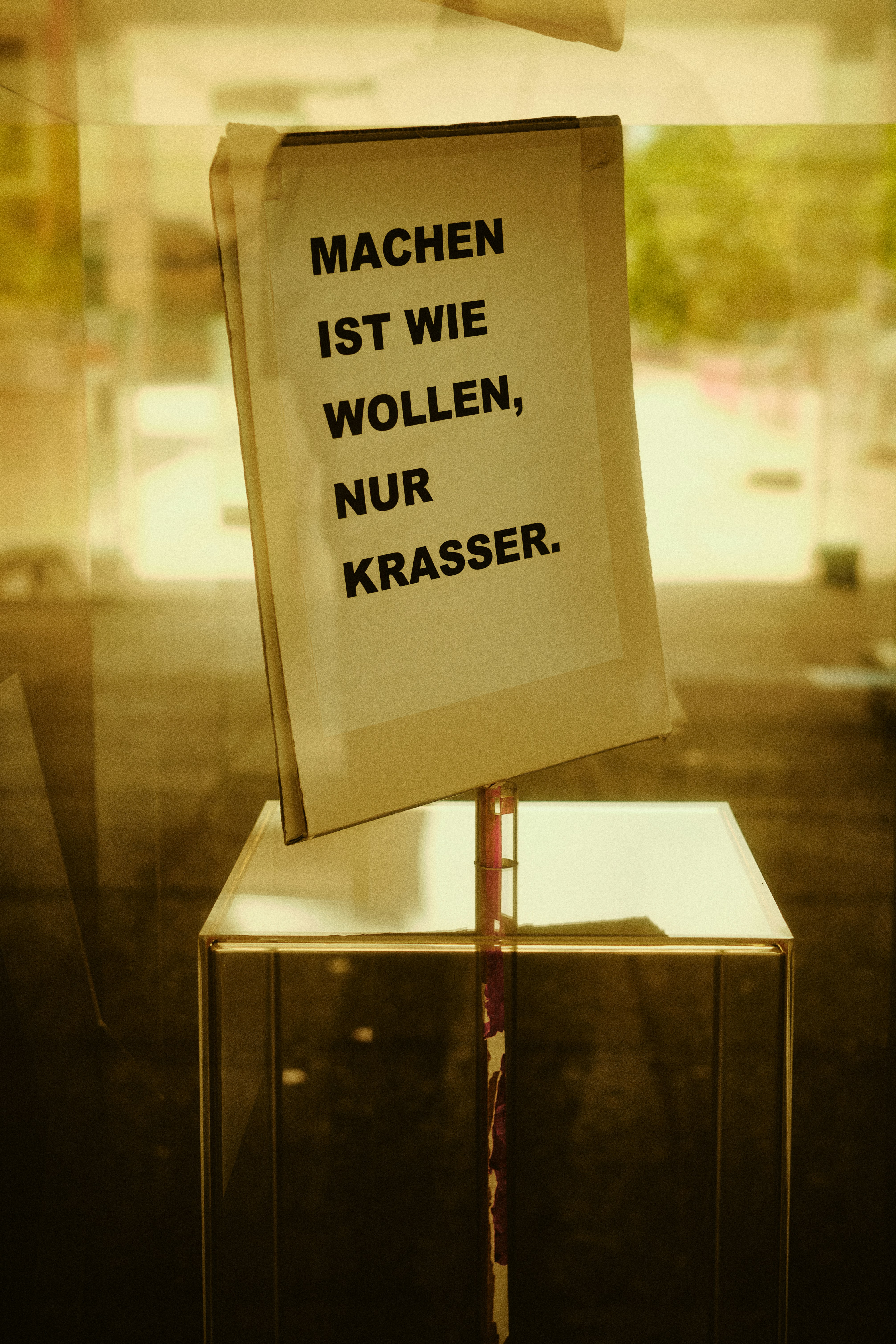 German protest poster on a glass pedestal, tilted and backlit