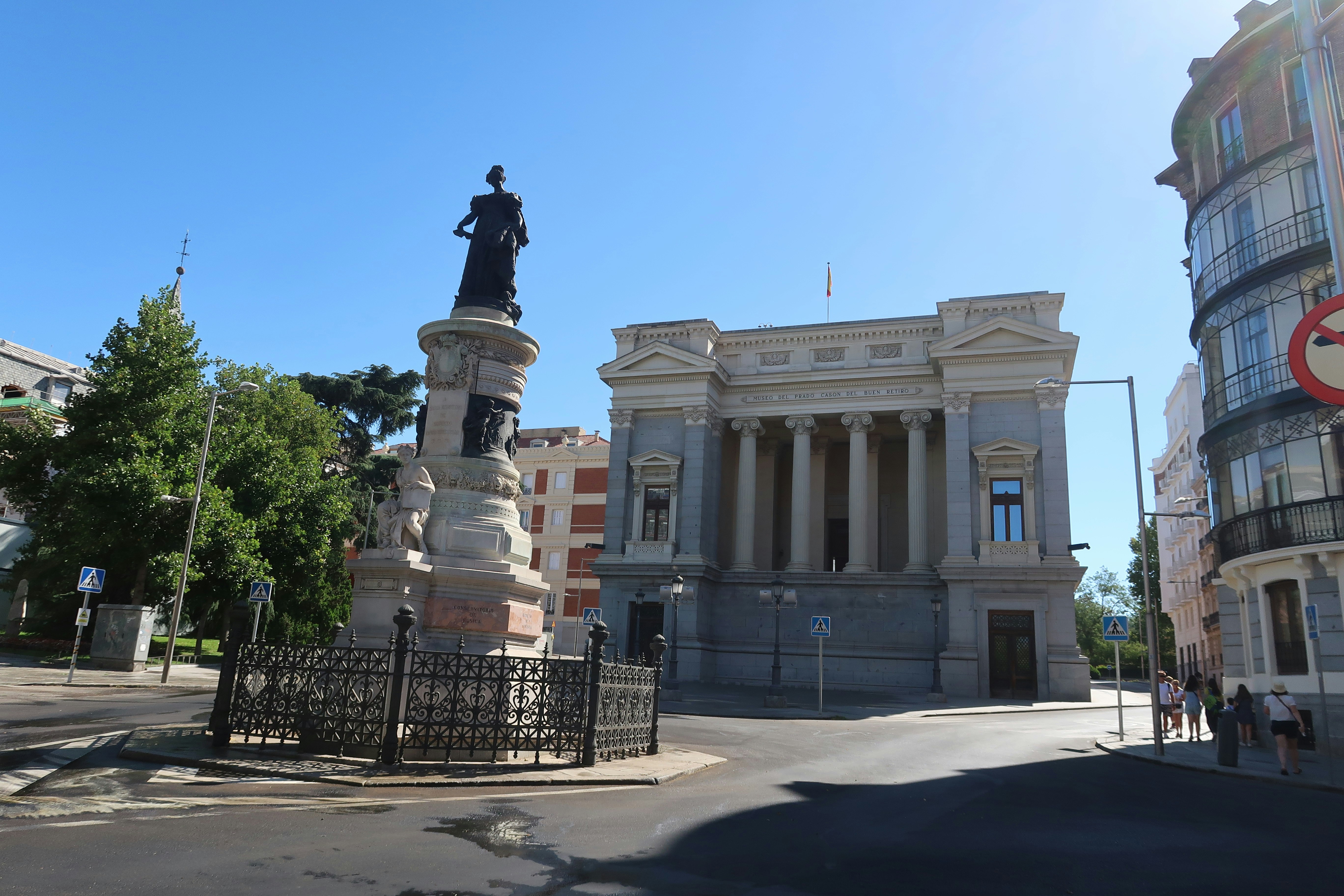 Classical Facade and Statue: A Sunlit Municipal Theatre Courtyard