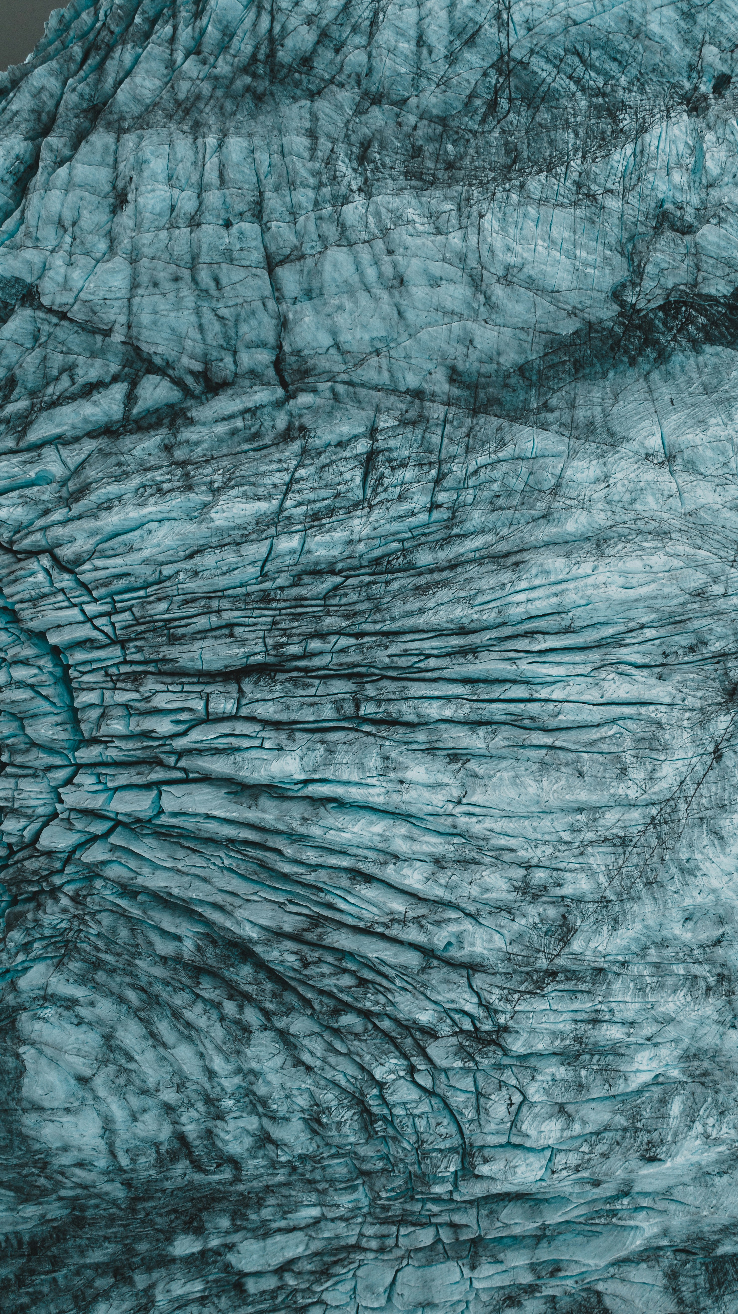 Glacial Striations: A Teal-Tinted Icefield's Veins