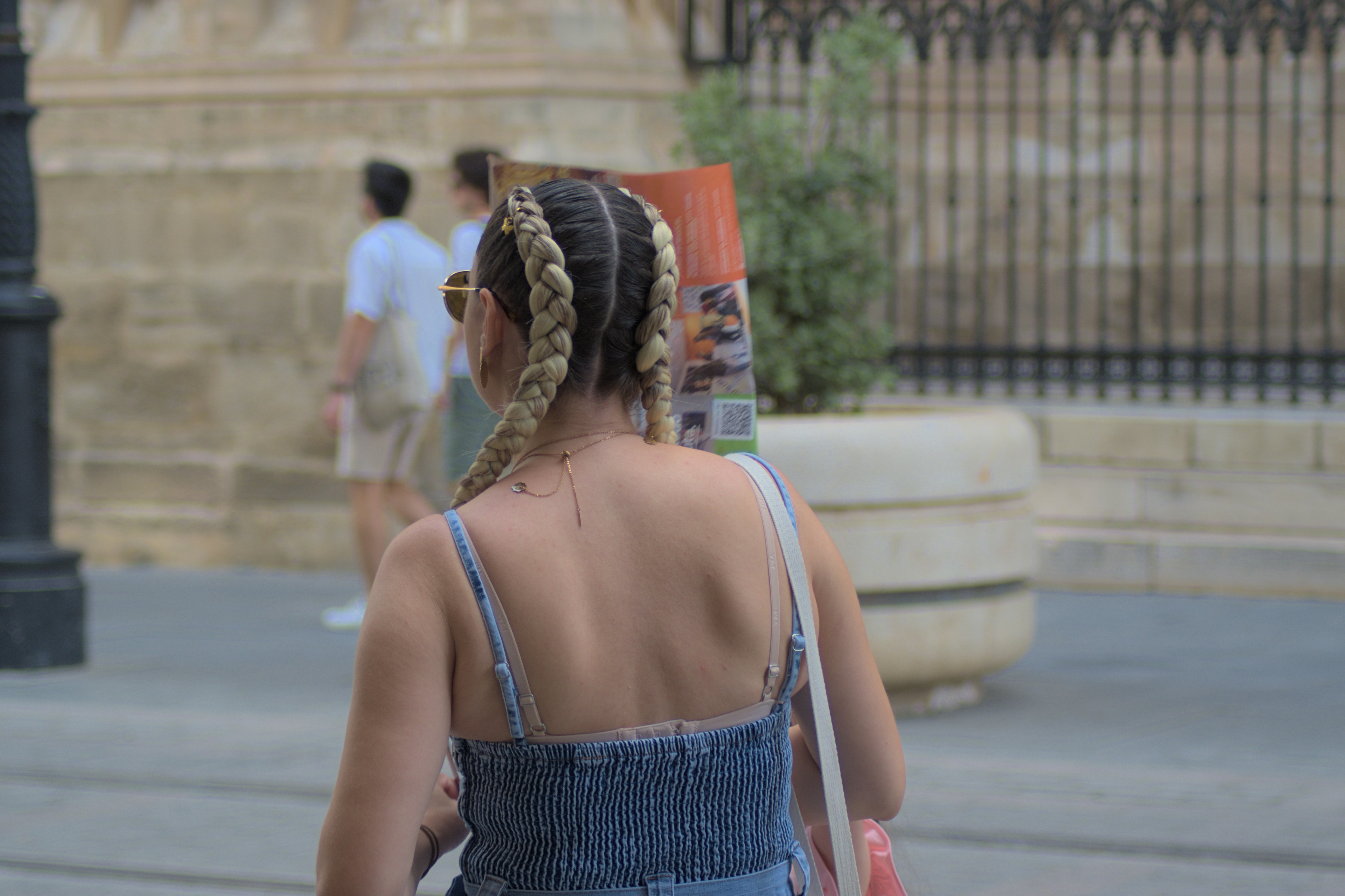 Braided Back and Urban Walking: A Quiet Street Portrait
