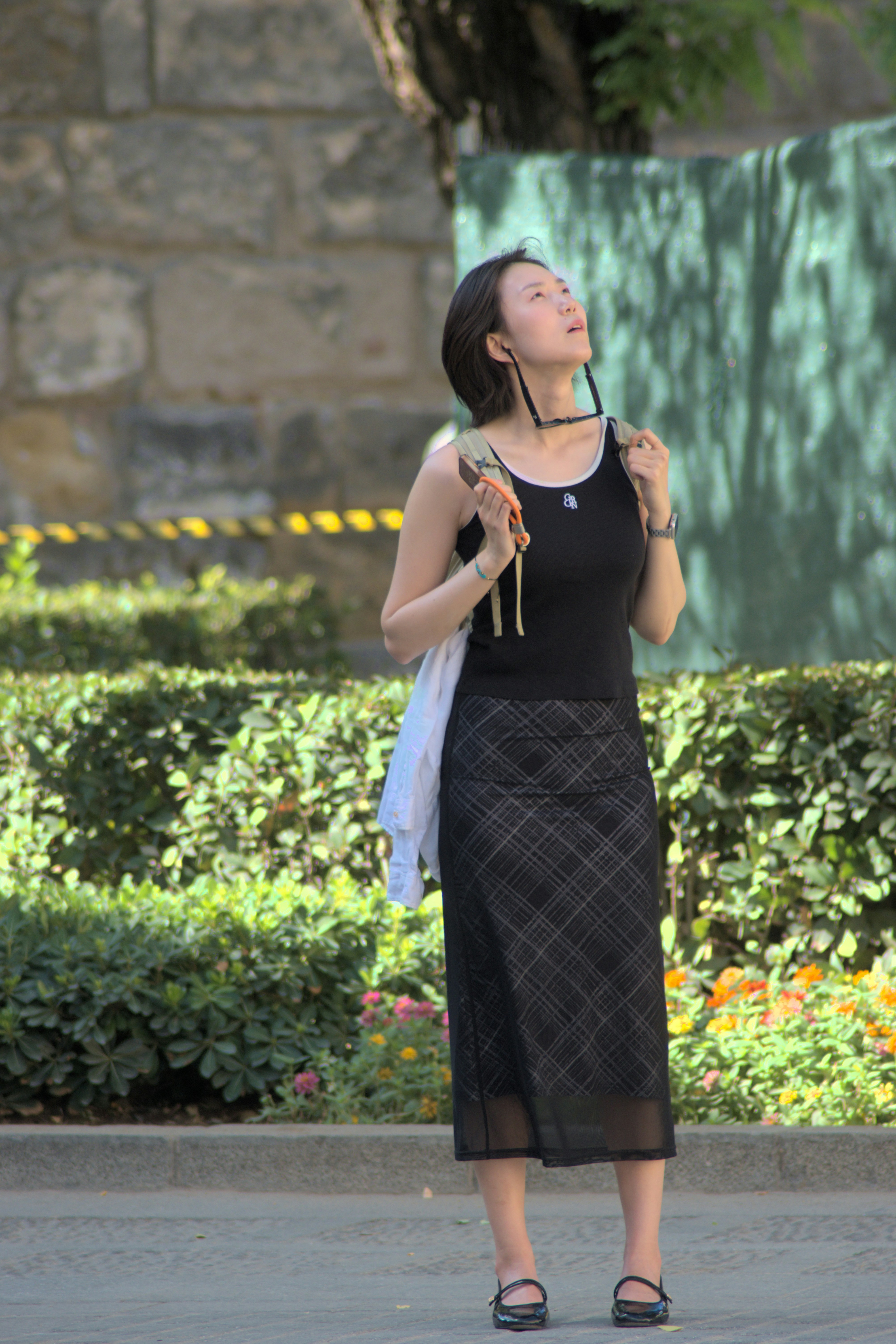 Elegance in Console Light: A Woman in Black Dress Admires the Sky