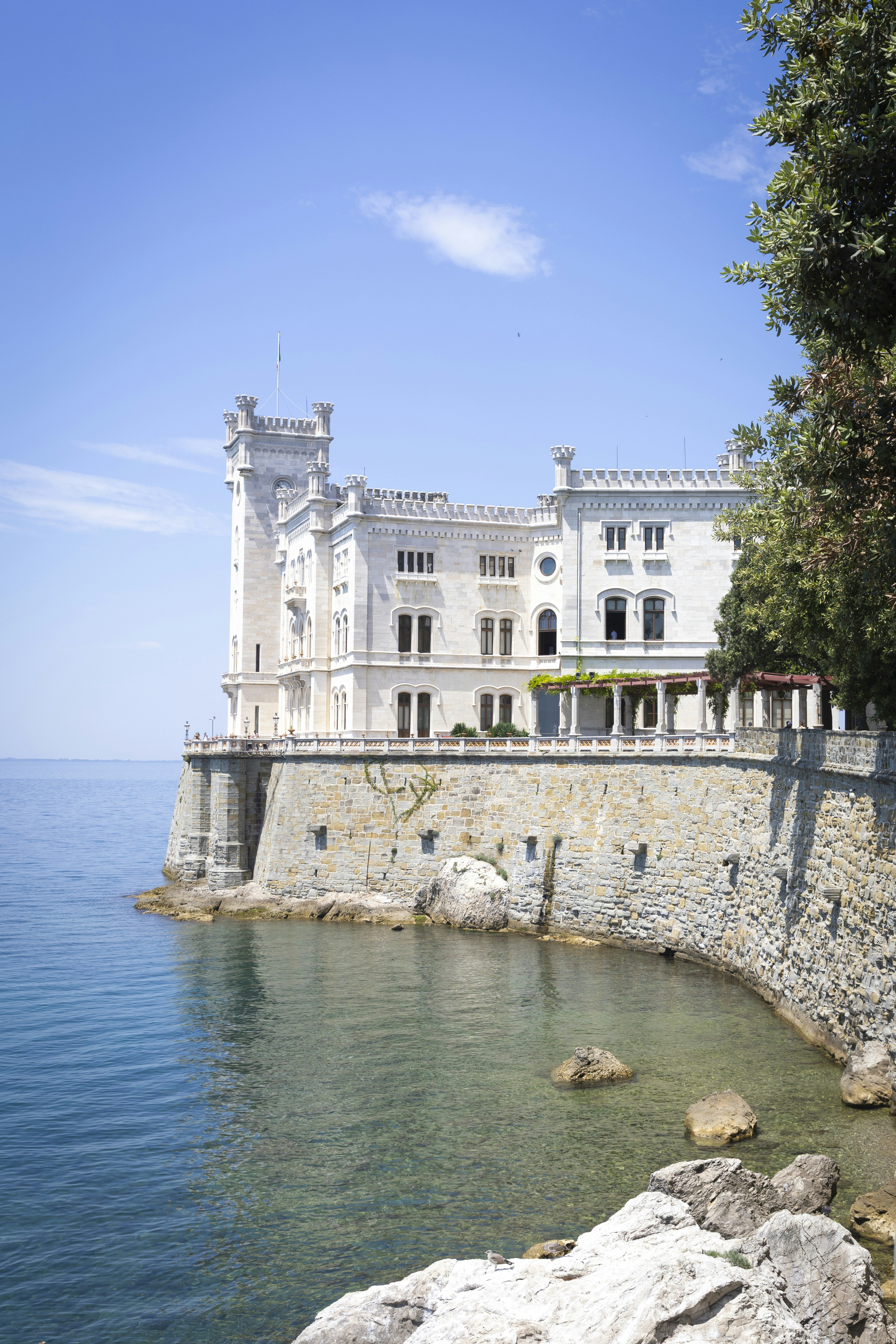 Castle Courtyard Over the Sea: A White Fortress Beside Quiet Waters