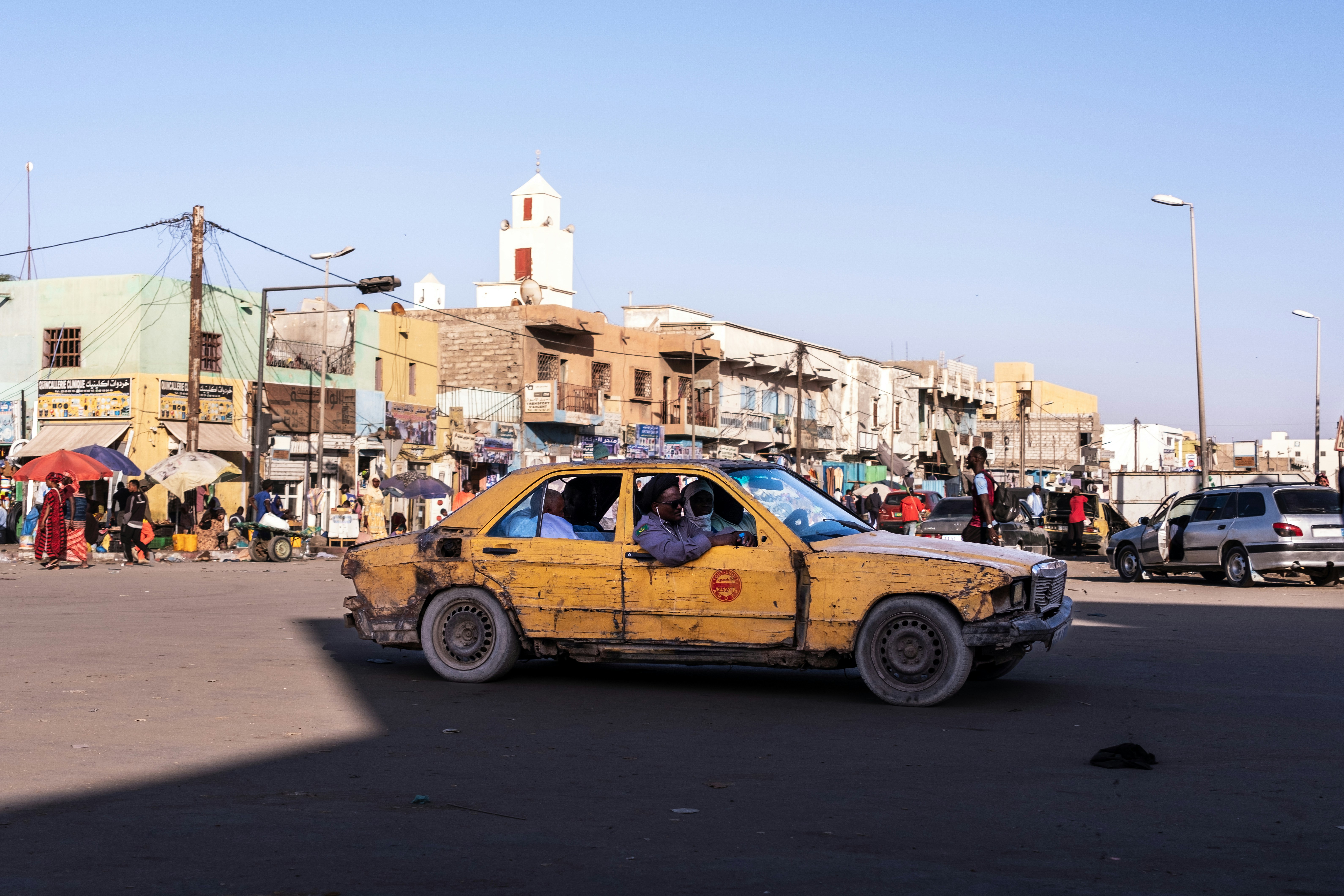 Dusty Yellow Taxi Cabs the Main Street in a Busy Market