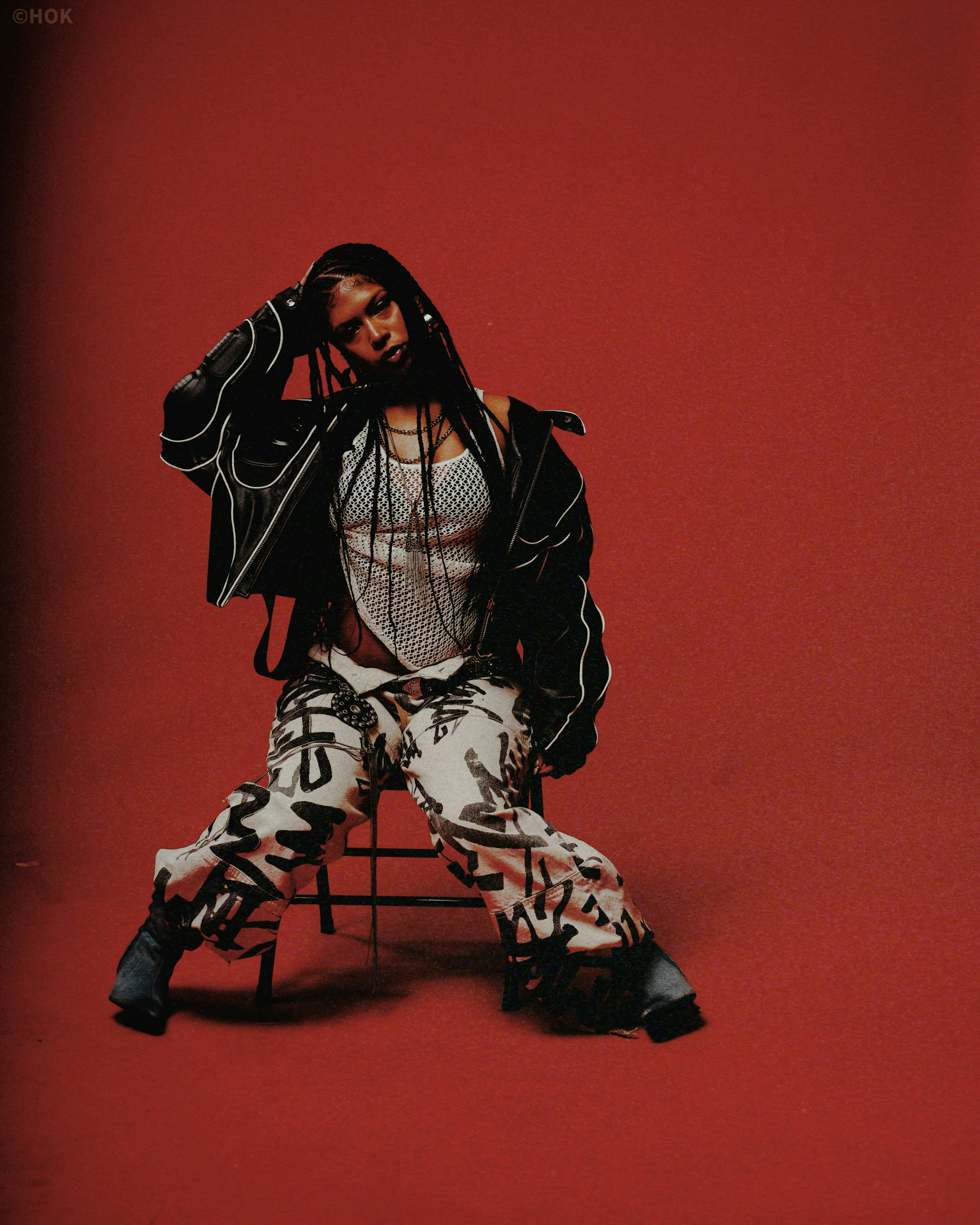 Red Studio Persona: A Portrait of Attitude in a Leather Jacket
