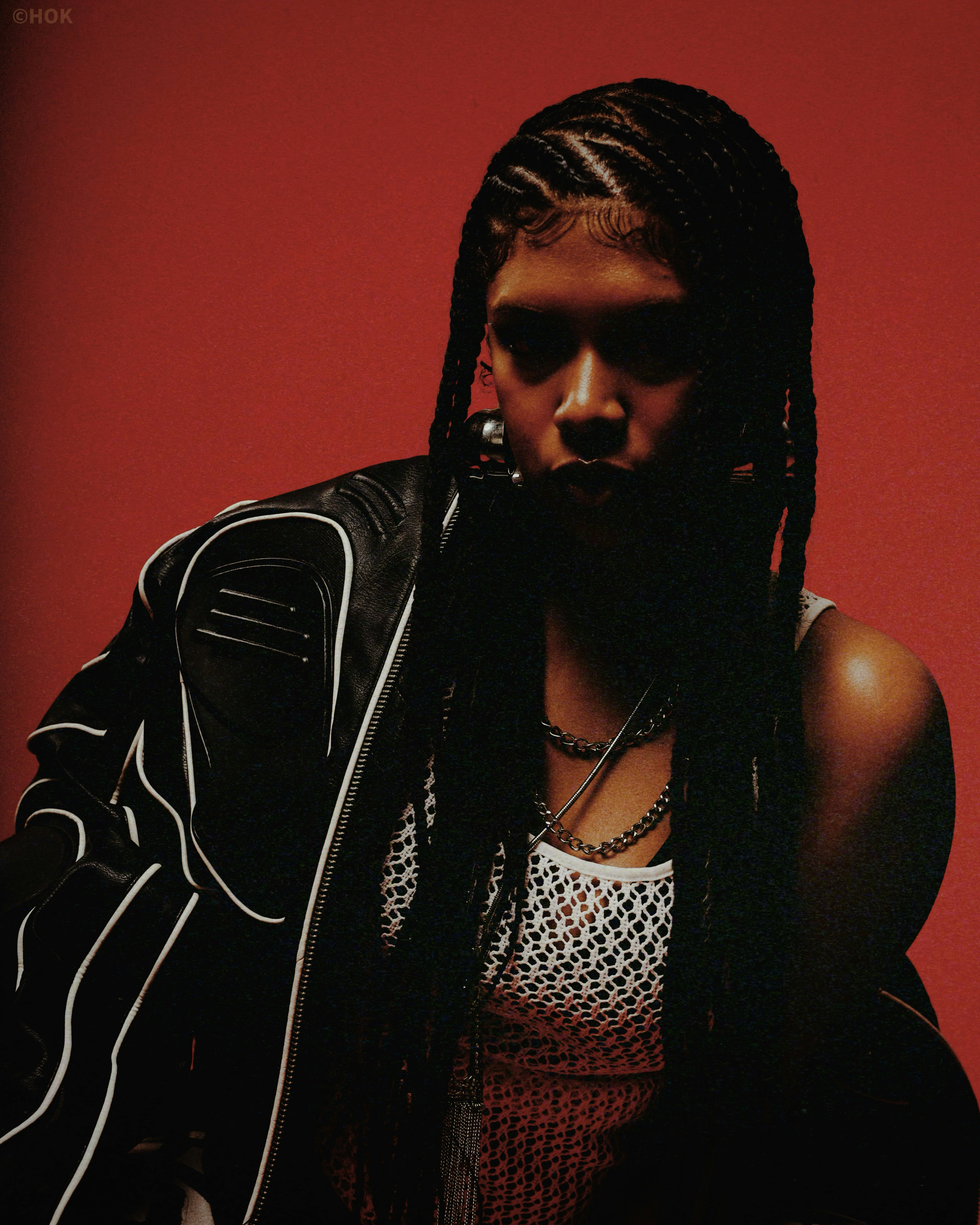 Low-Key Portrait in Red: A Steady Gaze Through Shadowed Grunge
