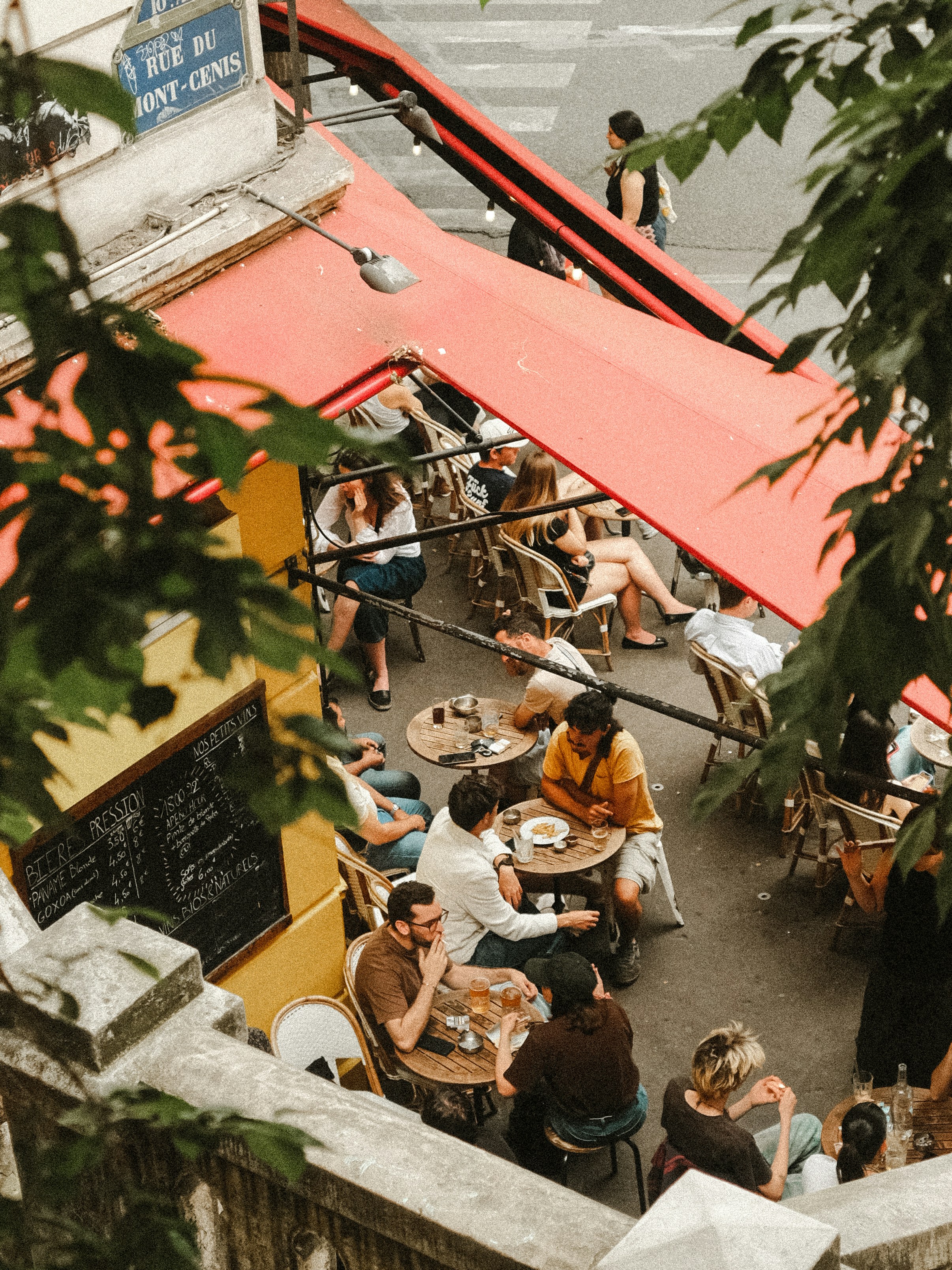 A Sunlit Terrace in the City: People Gather at Outdoor Café