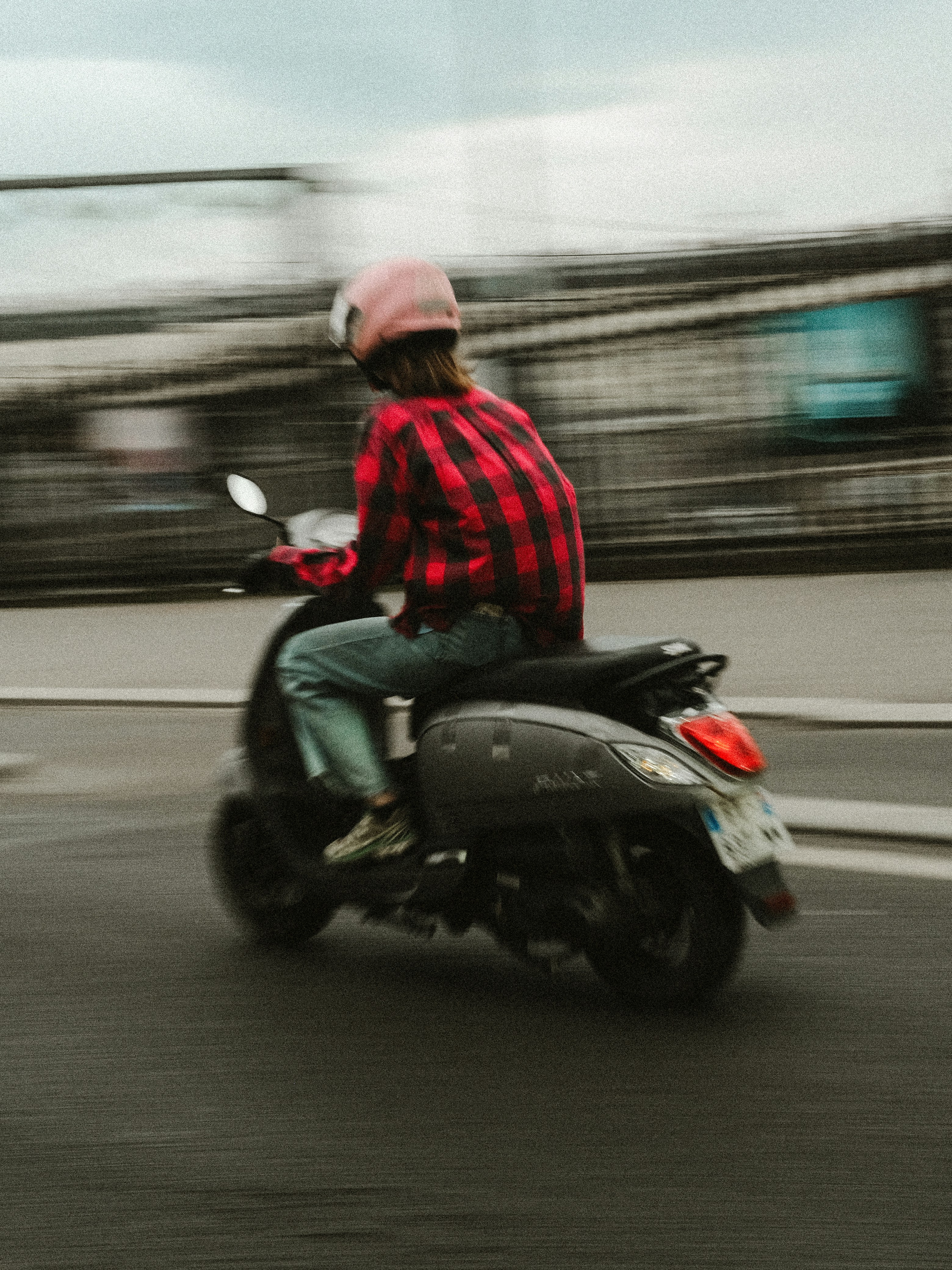Motion on the Move: rider in a red plaid shirt on a scooter