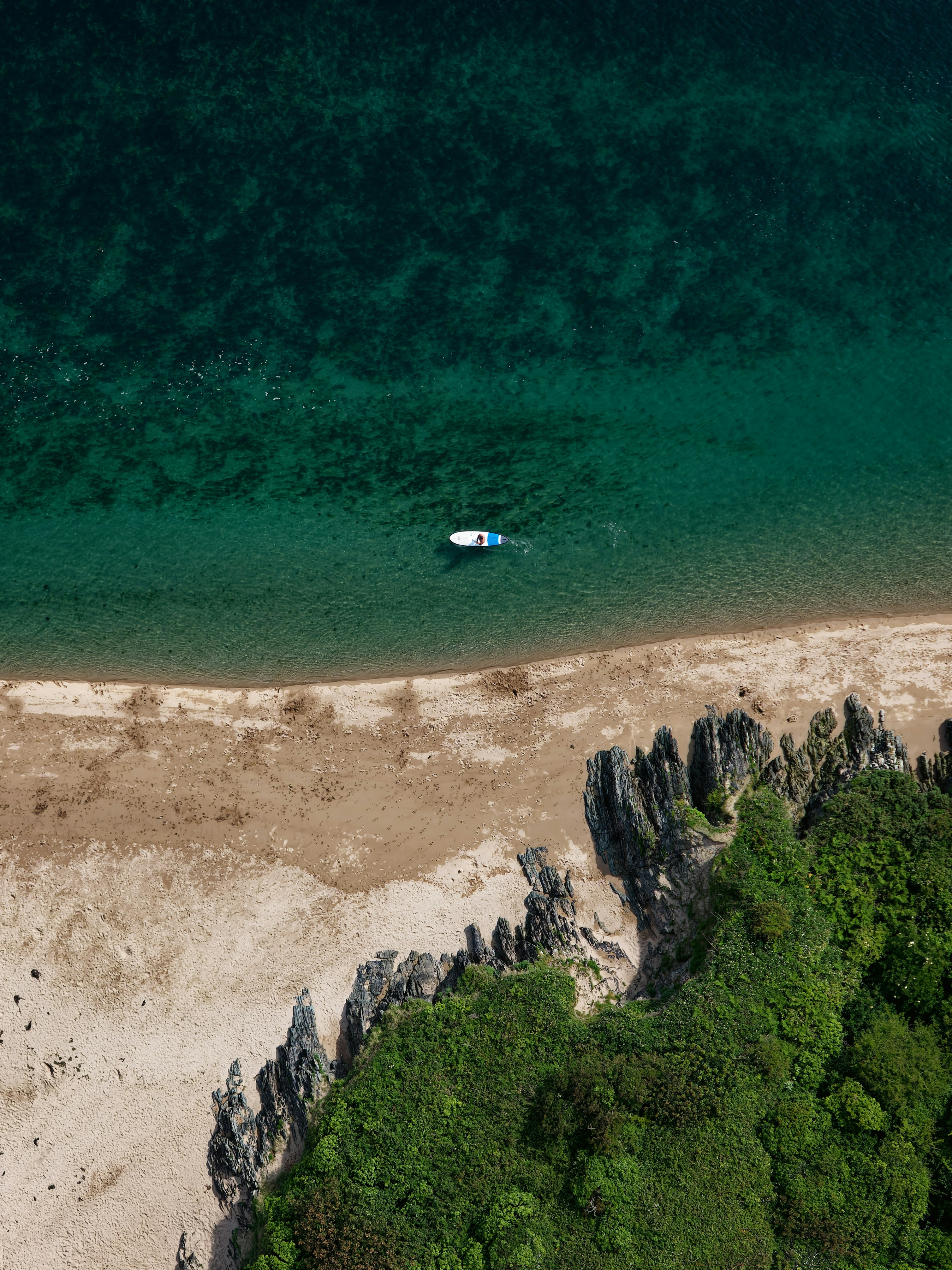 Solitary Boat in Emerald Shoreline