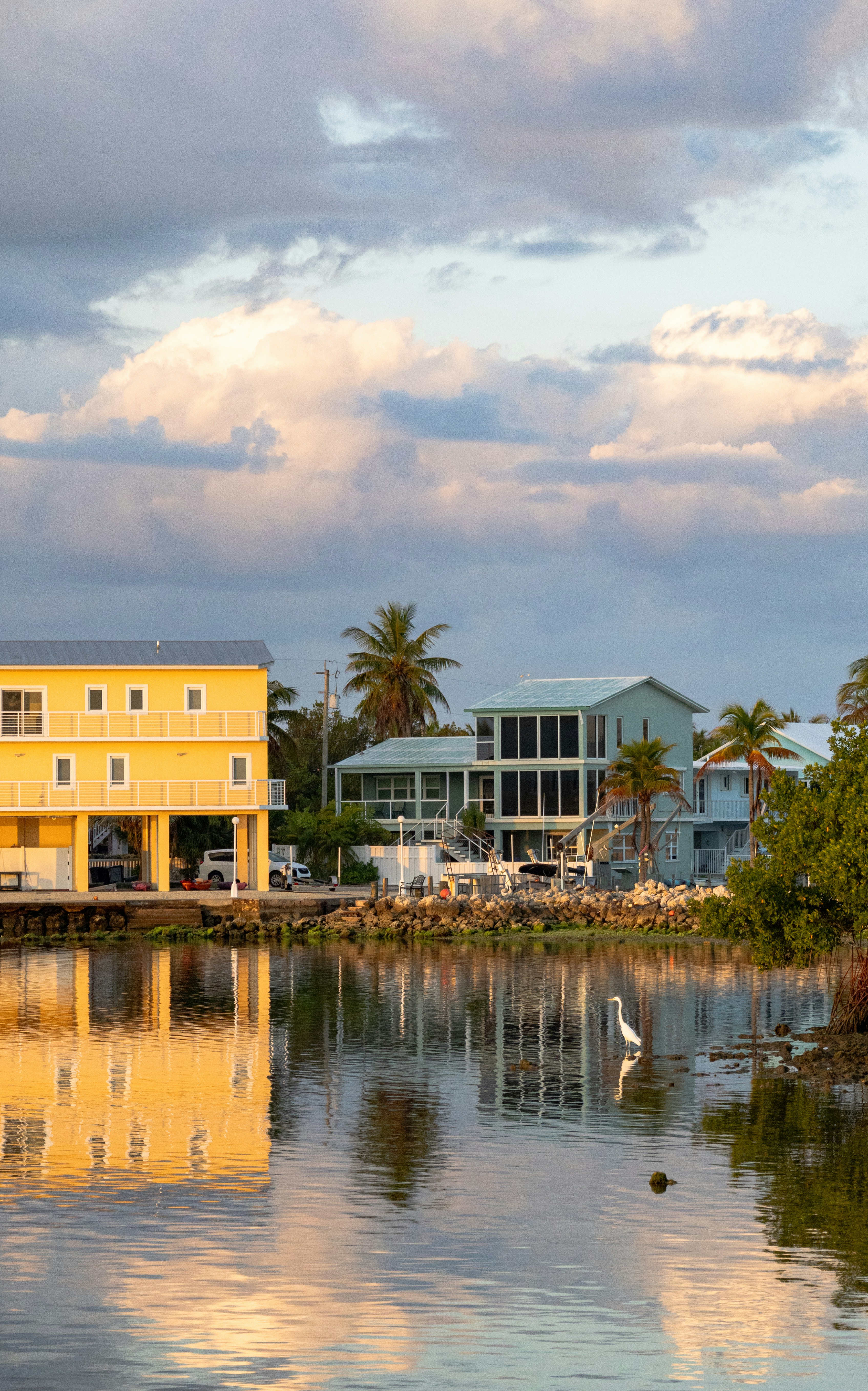 Sunlit Canal Homes Reflect on Calm Water