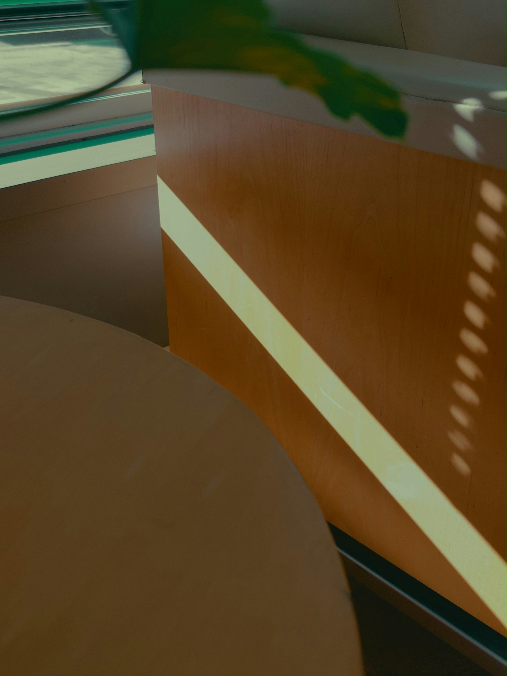 Sunlit Corner: Angular Wood Panel and Shadow Stripe