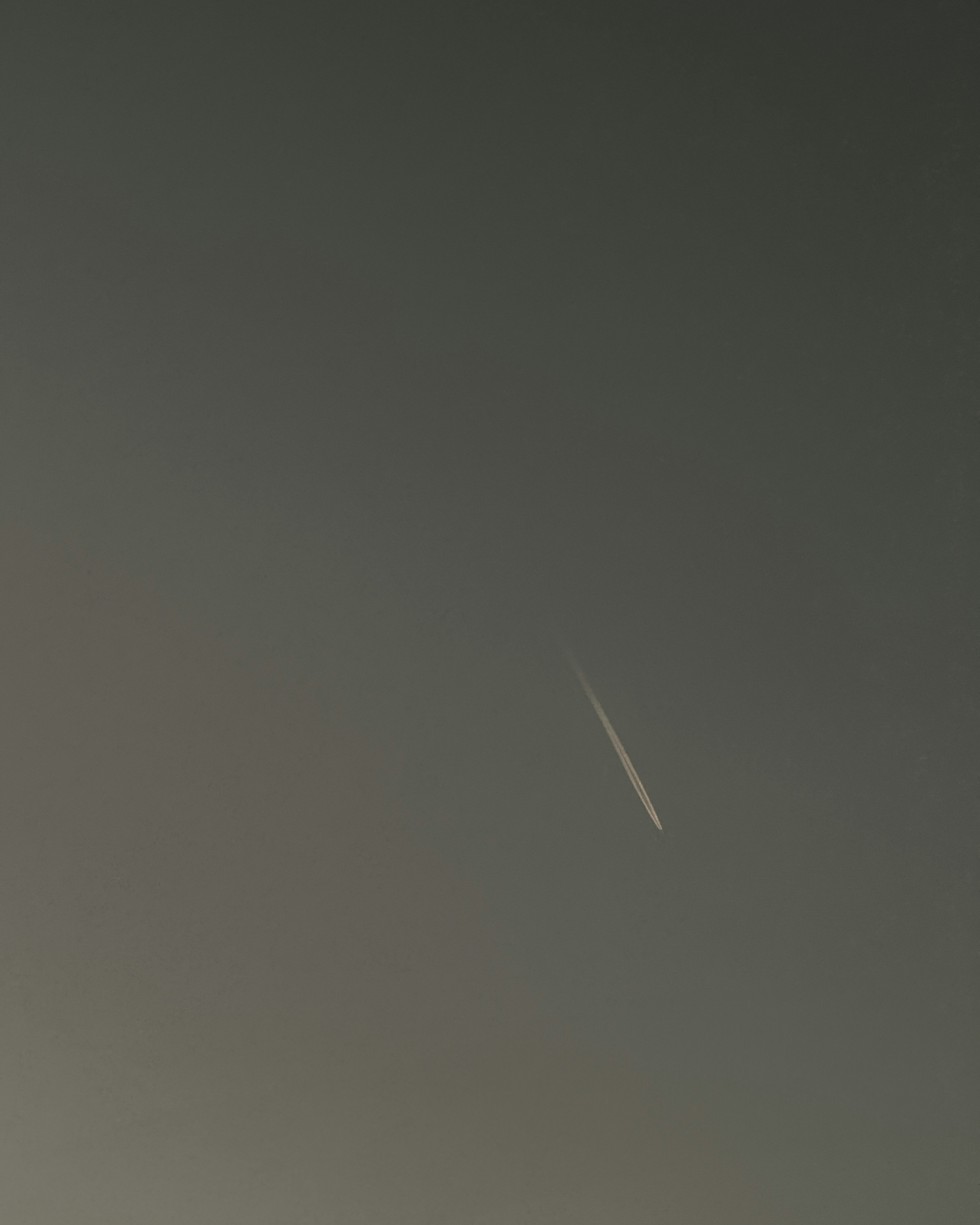 Celestial Contrail Across Evening Sky