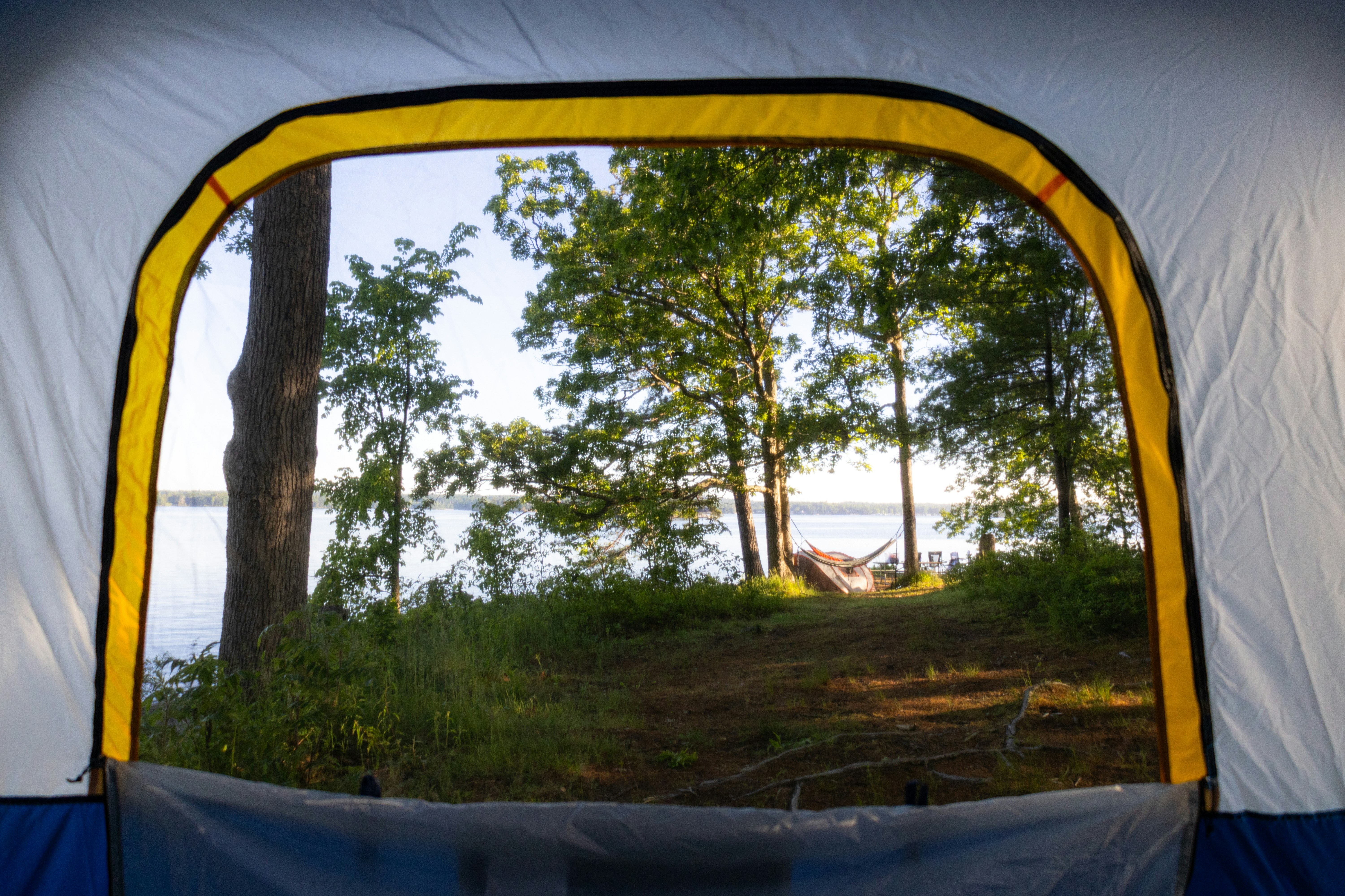 Camping View Through a Tent Aperture at Dappled Lakeside