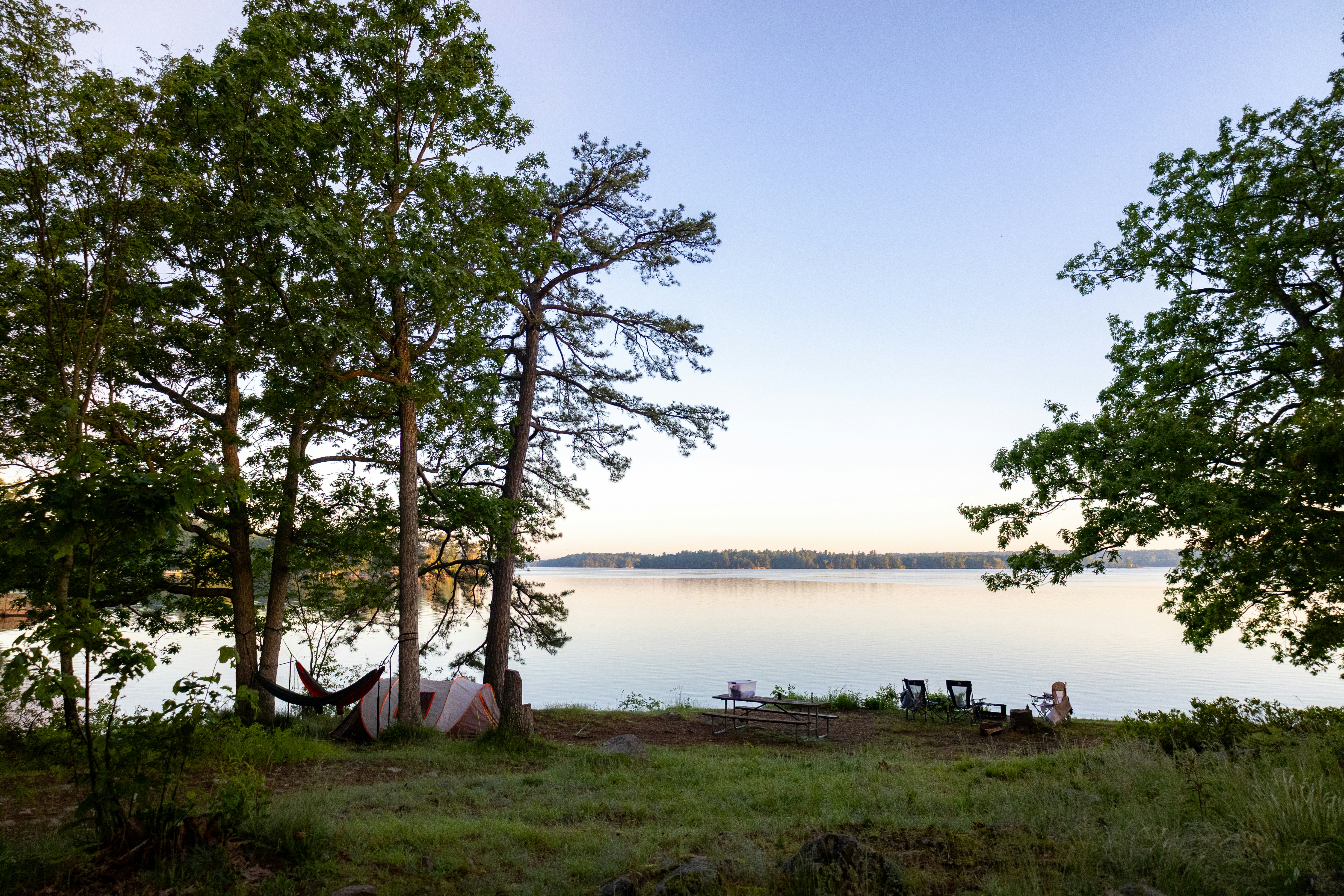 Lakeside Camp at Dusk: Quiet Shoreline Beneath Tall Pines