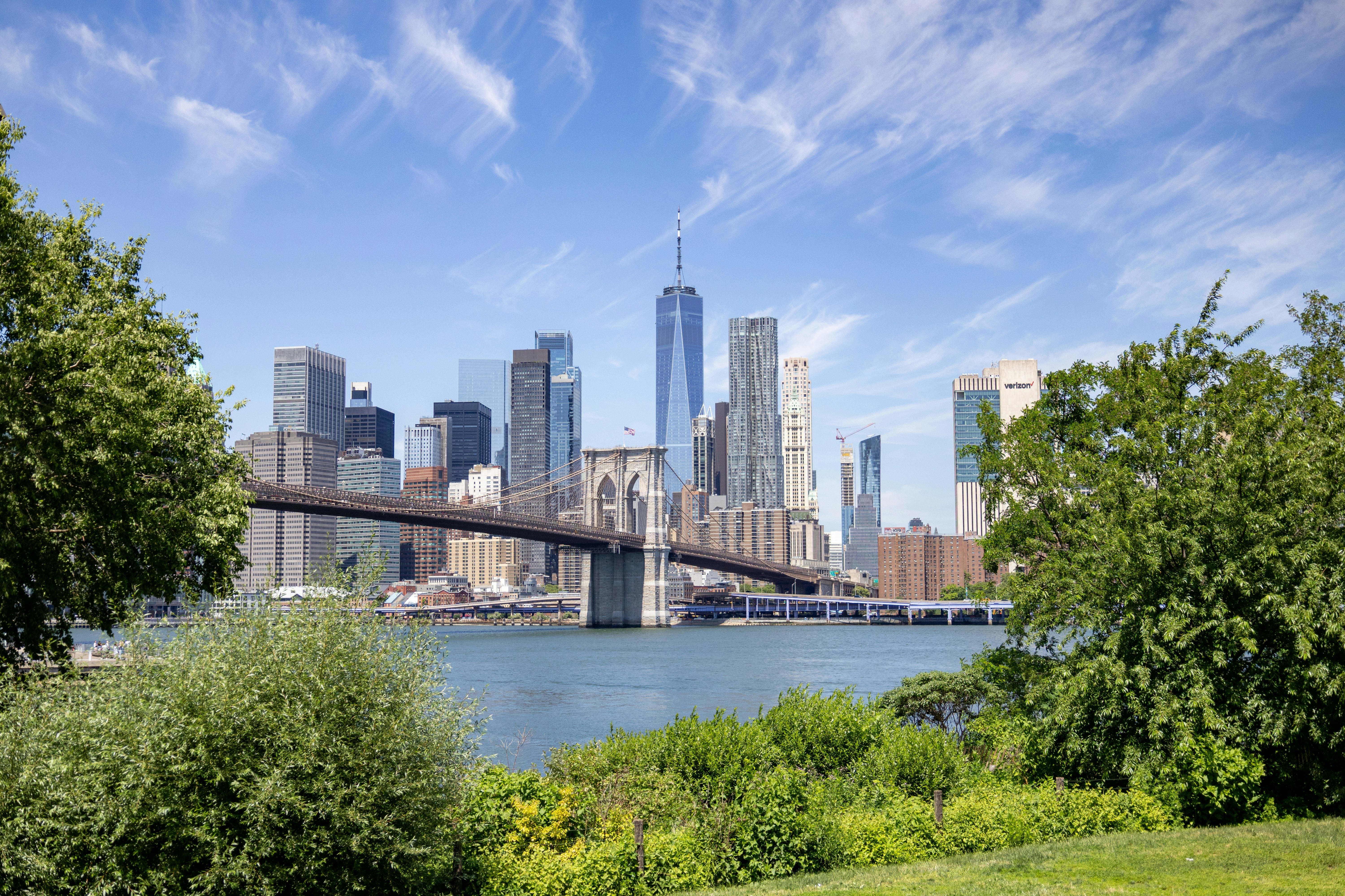 Brooklyn Bridge Dawn: Cityscape Surrounded by Green