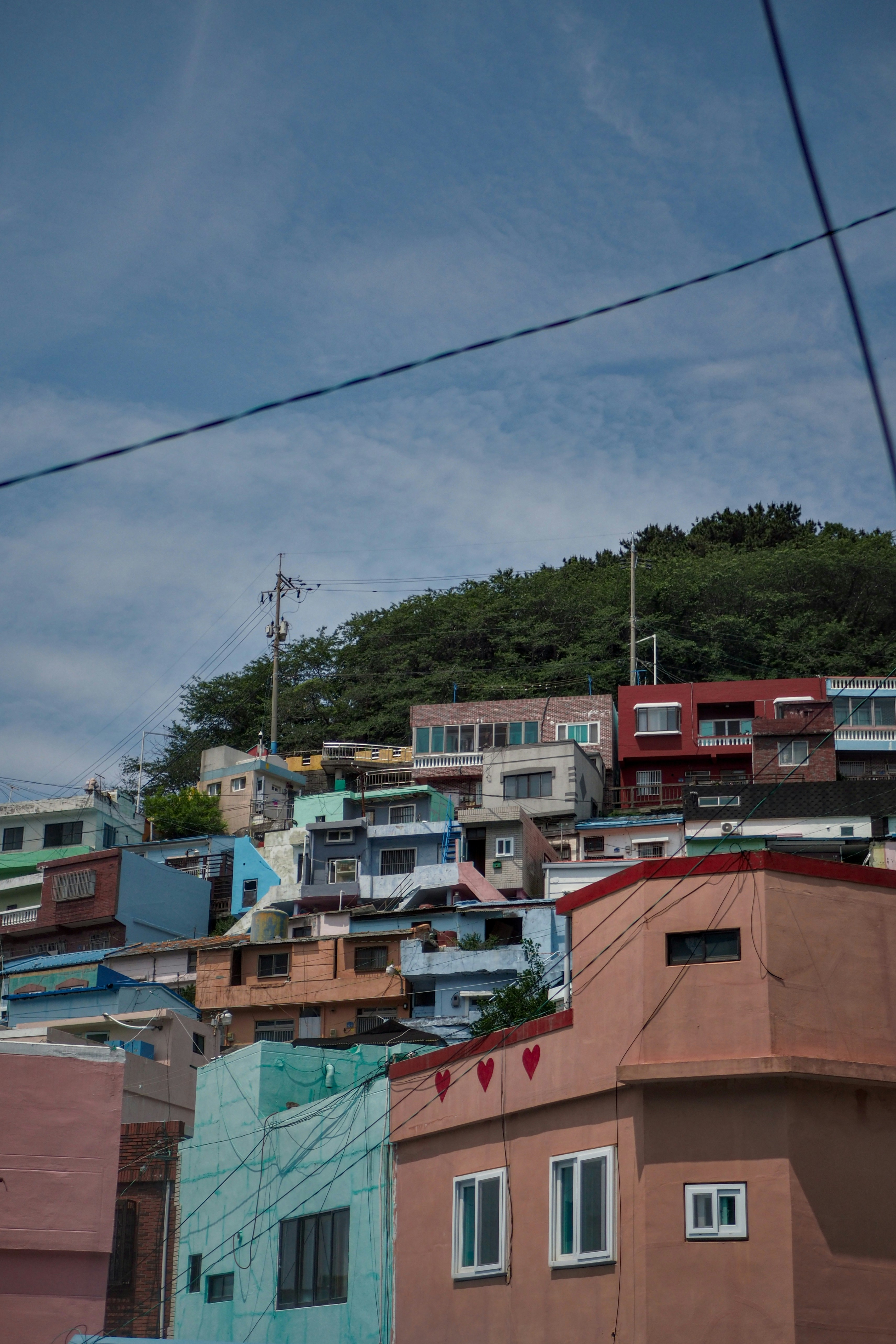 Colorful hillside houses under a blue sky