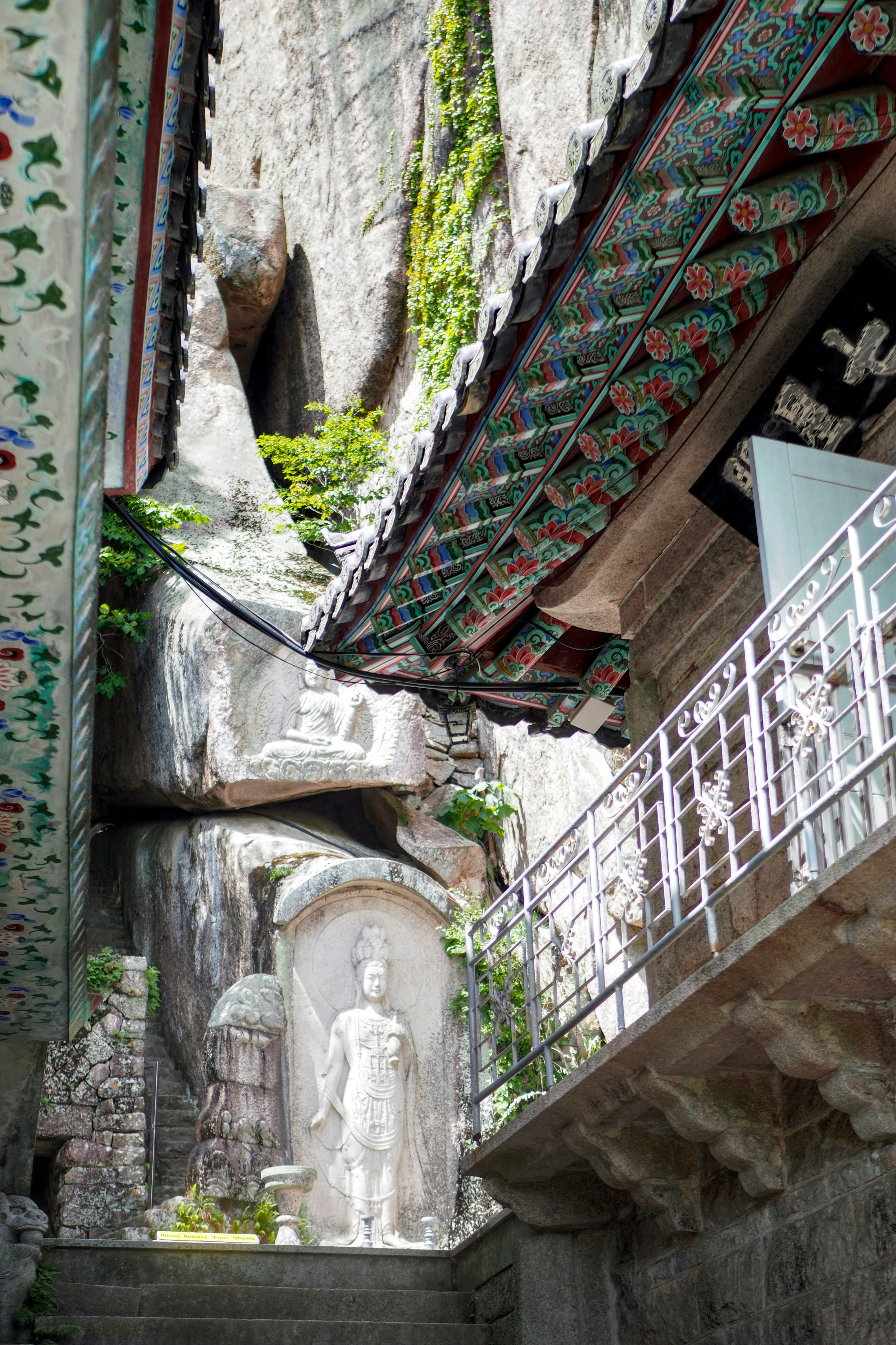 Stone Buddha Courtyard Between Decorated Rooflines