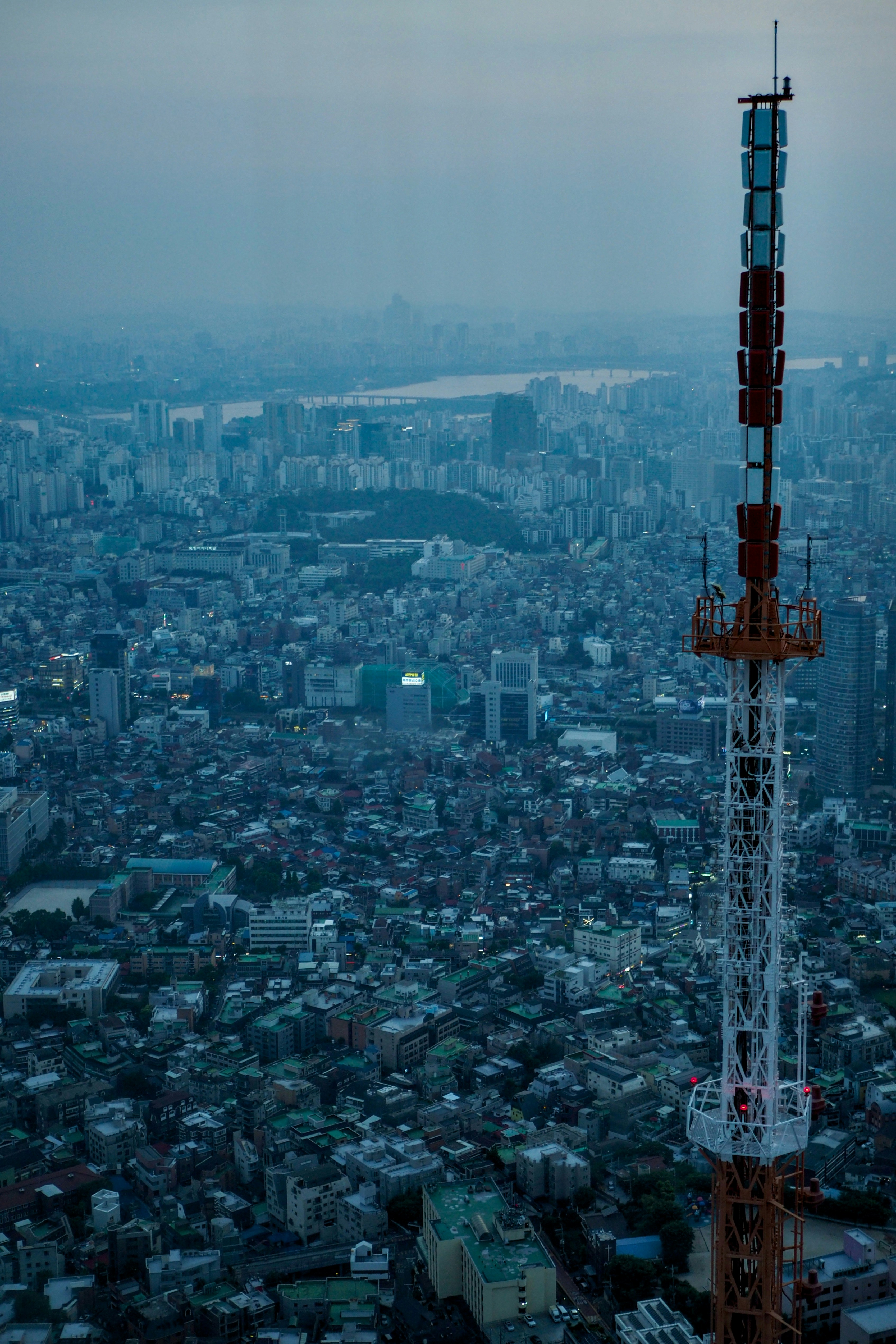 Urban Skyline Under a Tower: A City’s Veil of Blue