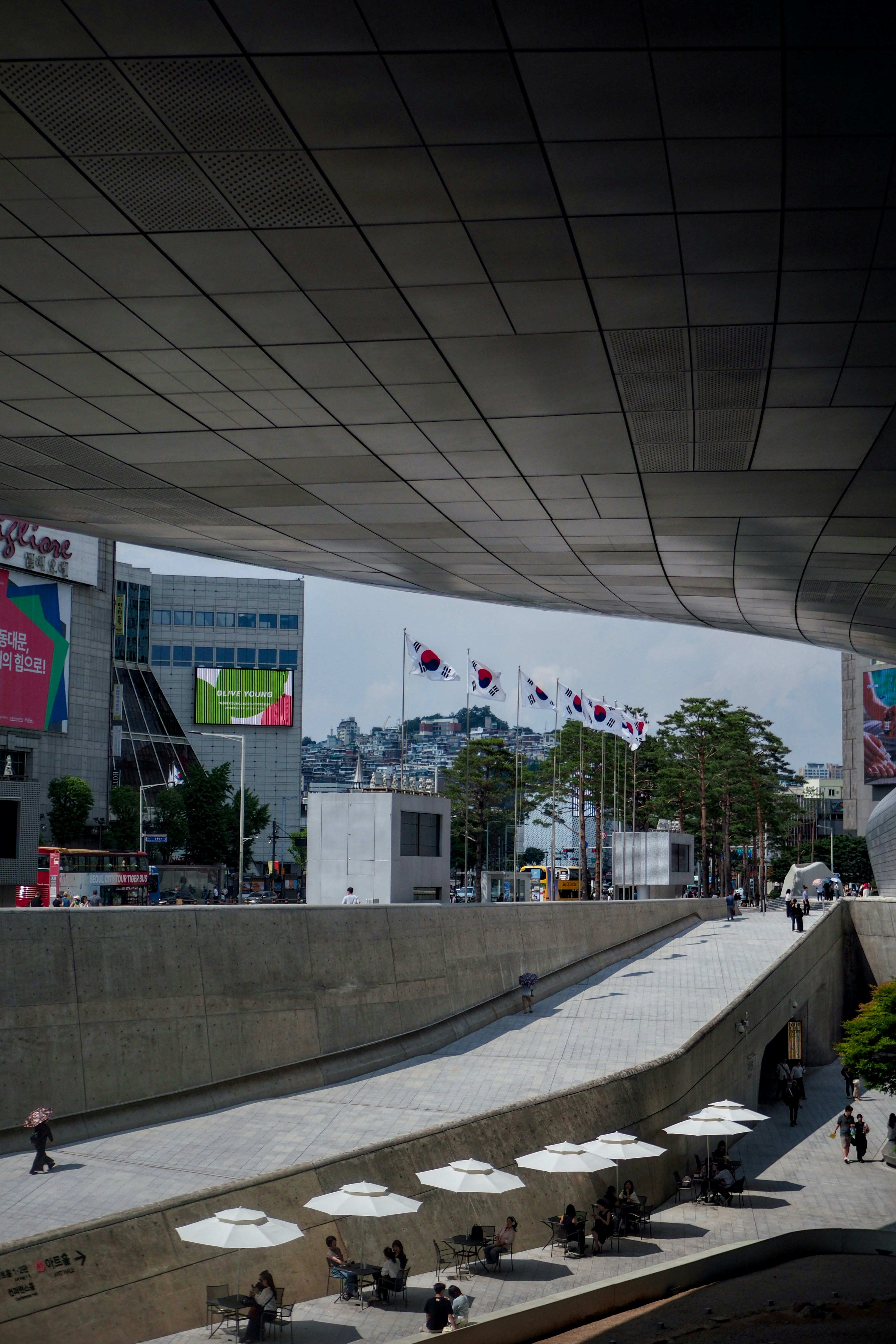 Under the Canopy: City Walk Under a Striking Overhang